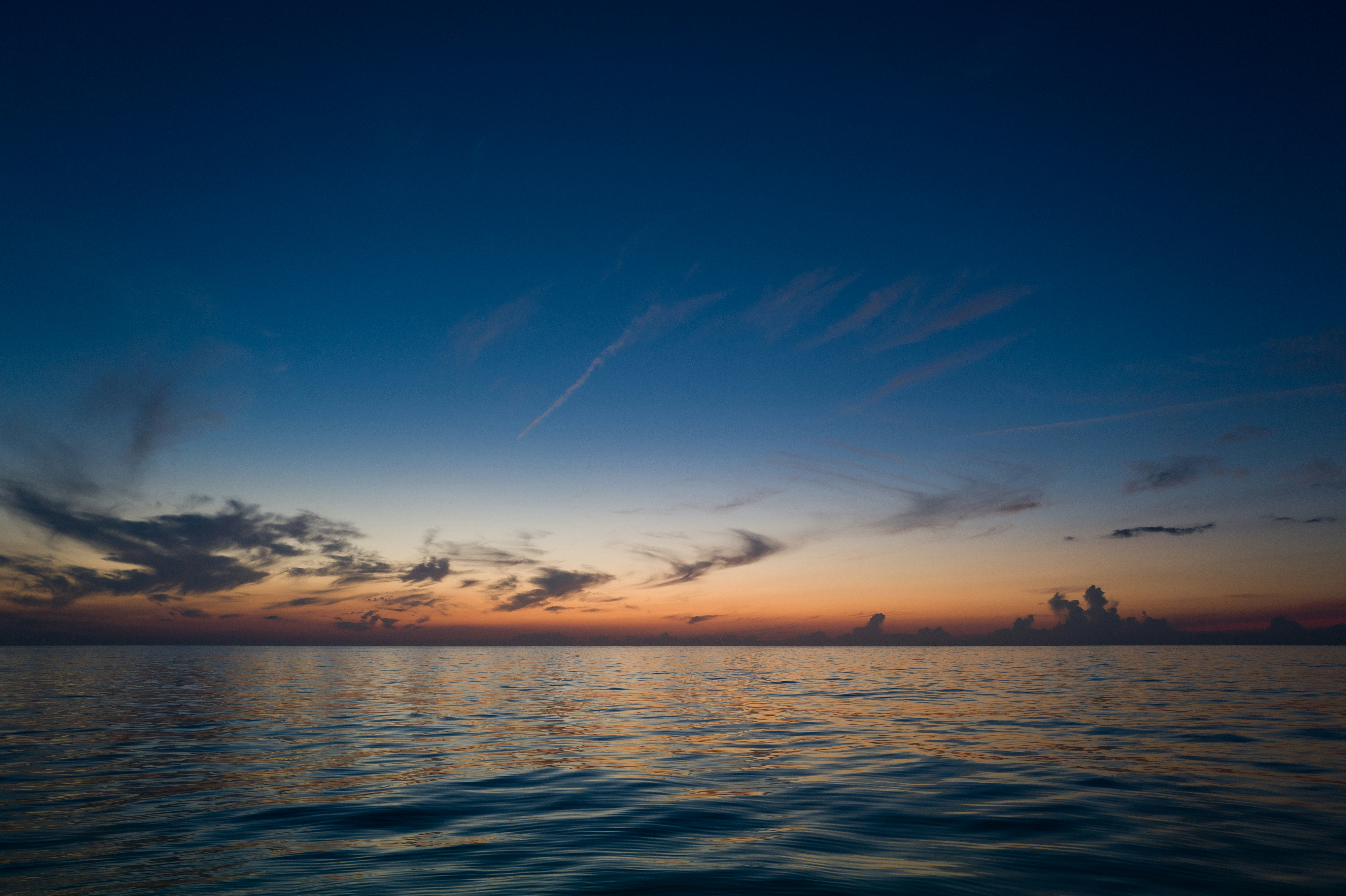 Vibrant sunset over calm ocean waters.