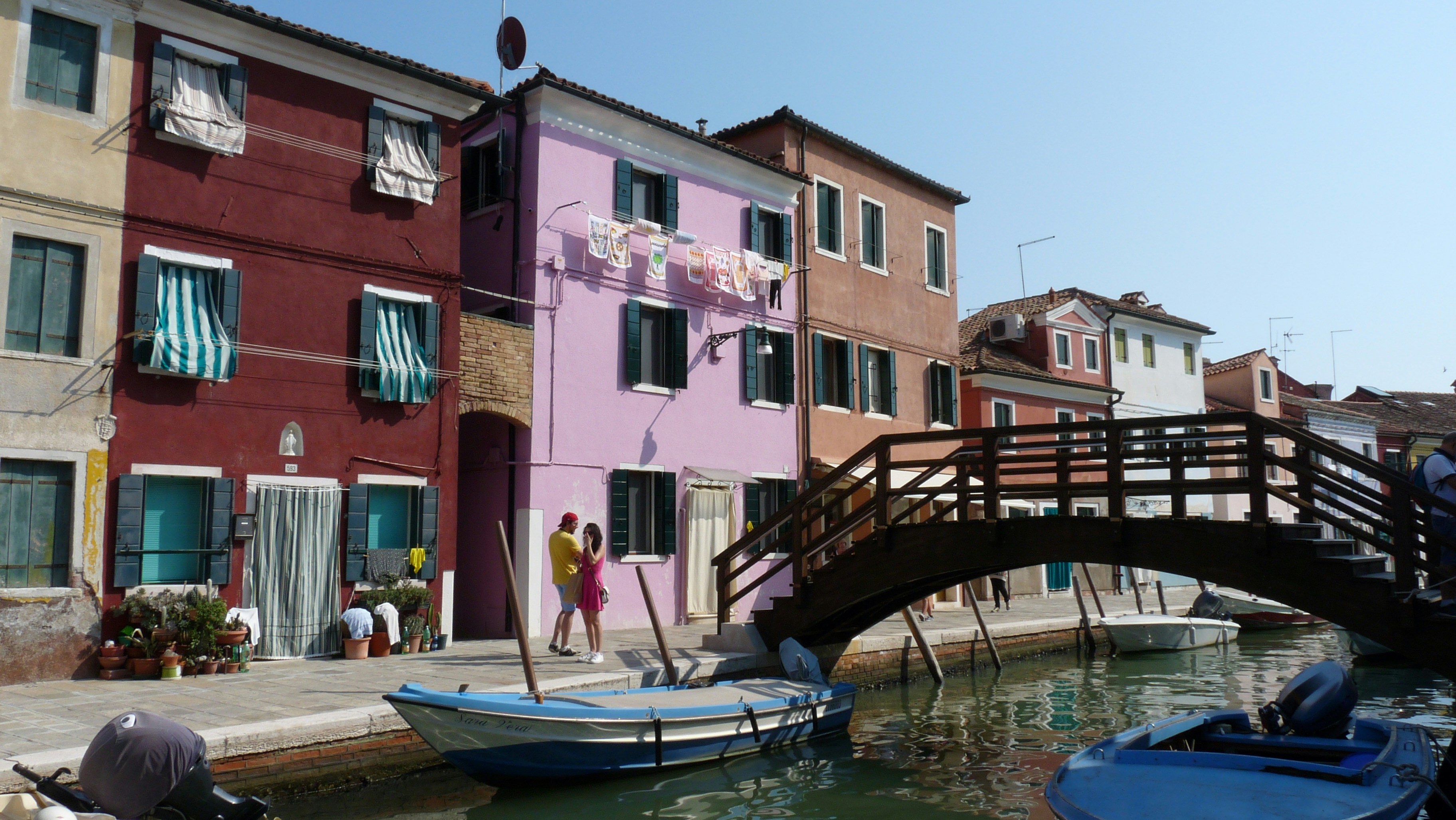 Vivid Facades over the Canal: A Colorful Venetian-Style Quarter by the Bridge