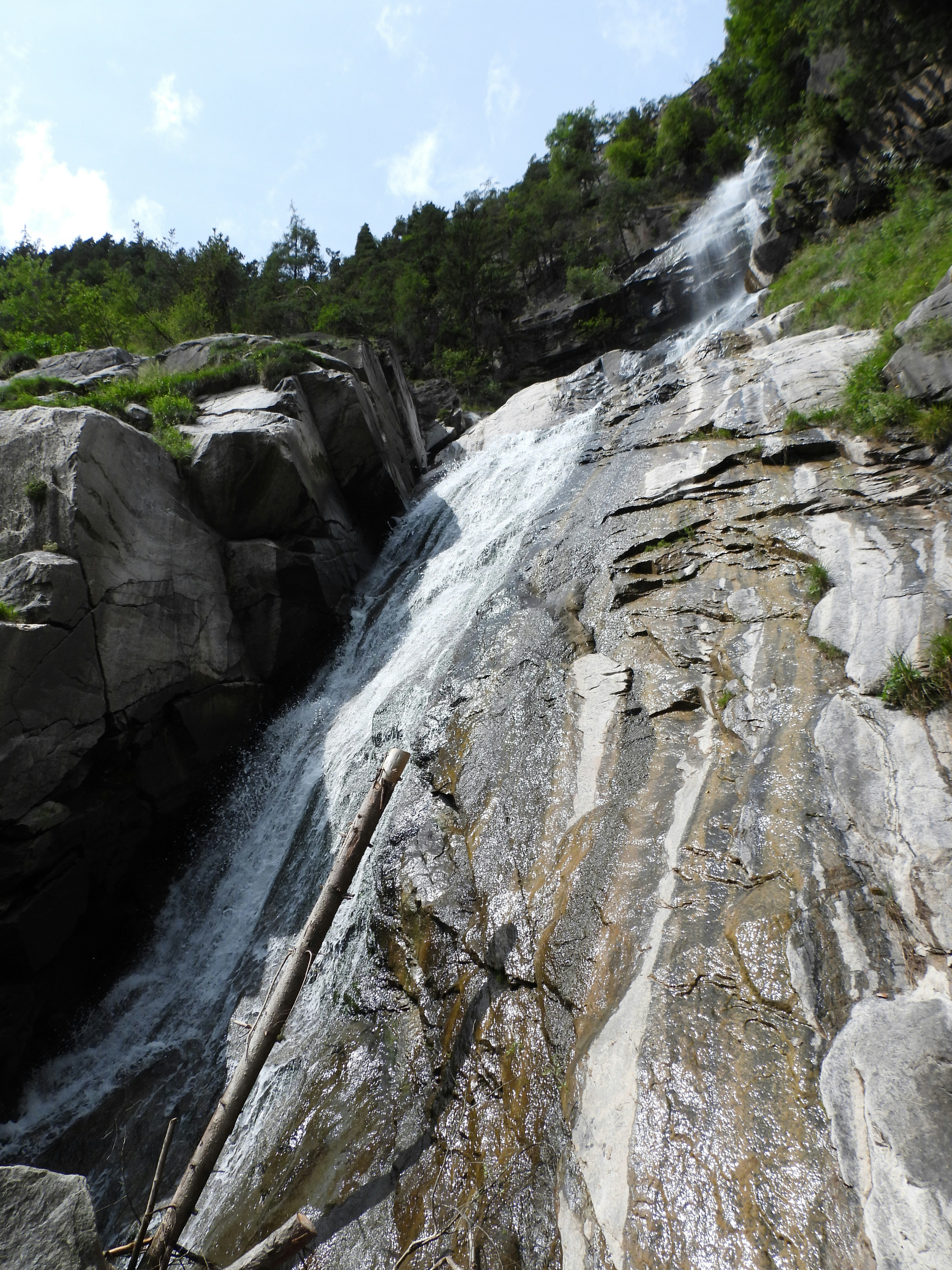 Rugged Cascade: A Sliver of Water Carving a Mountain Slab