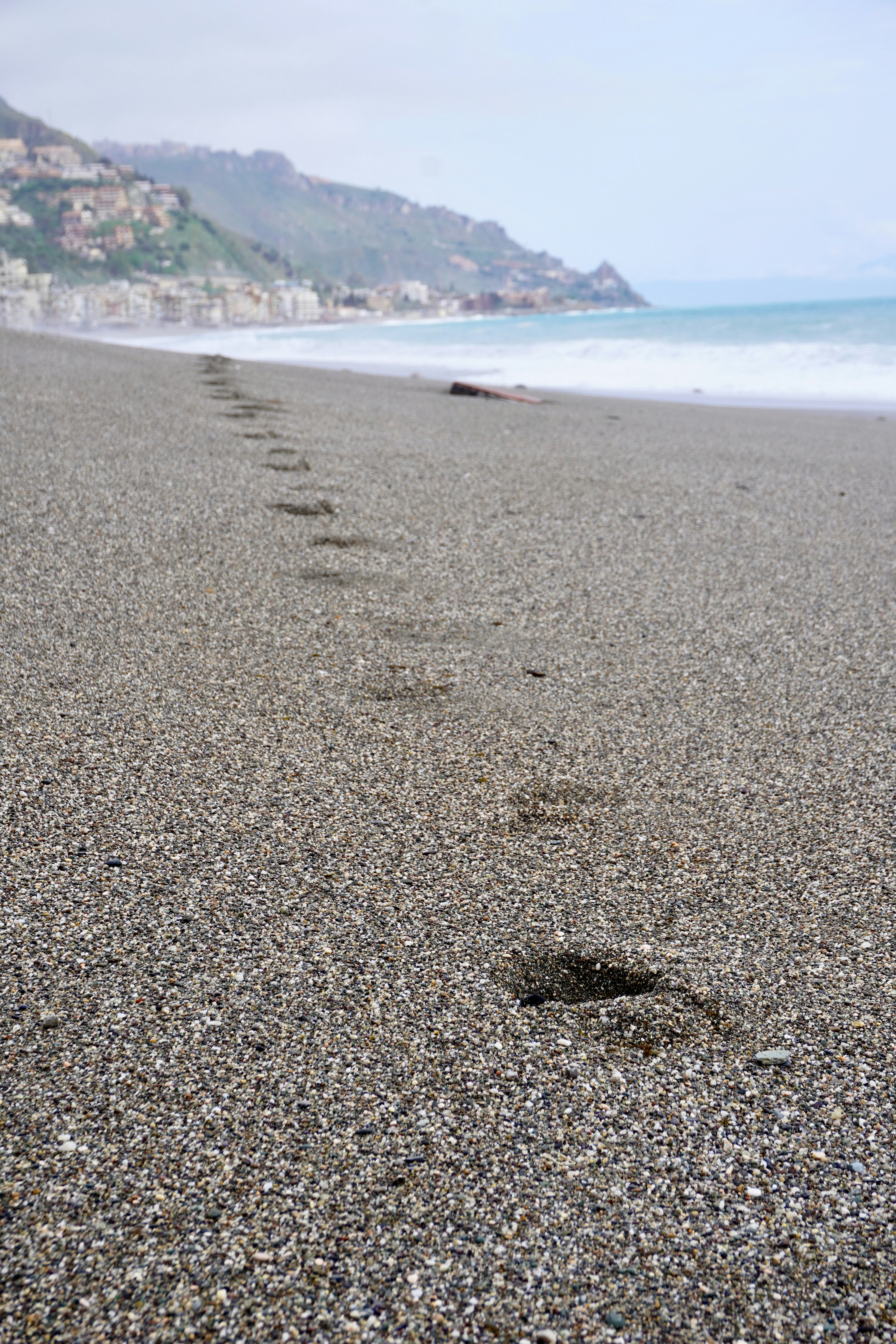 Footprints to the Horizon: A Pebbled Beach Walk