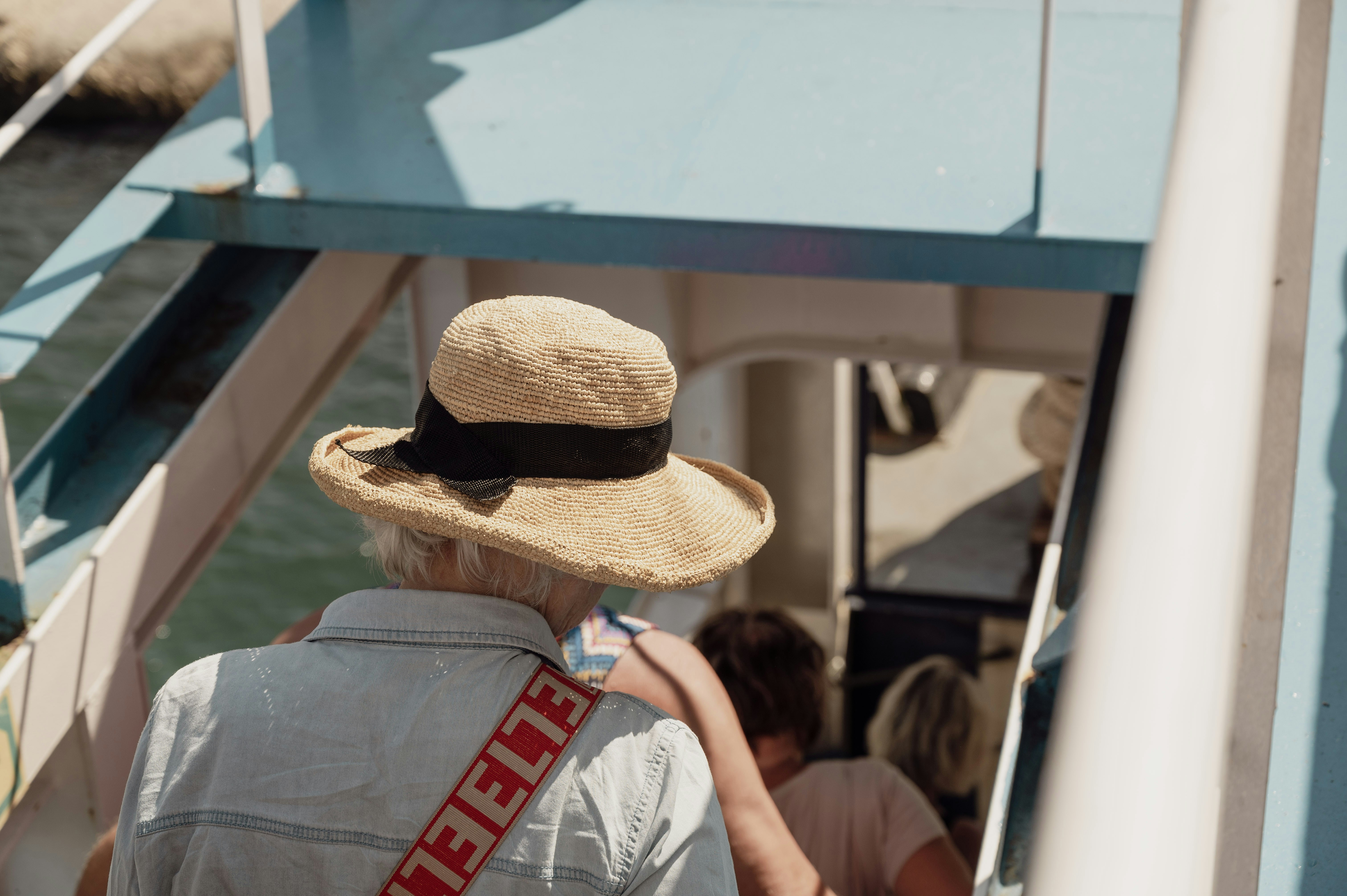 Sunlit Hat and Red Strap: A Quiet Moment Aboard the Dock