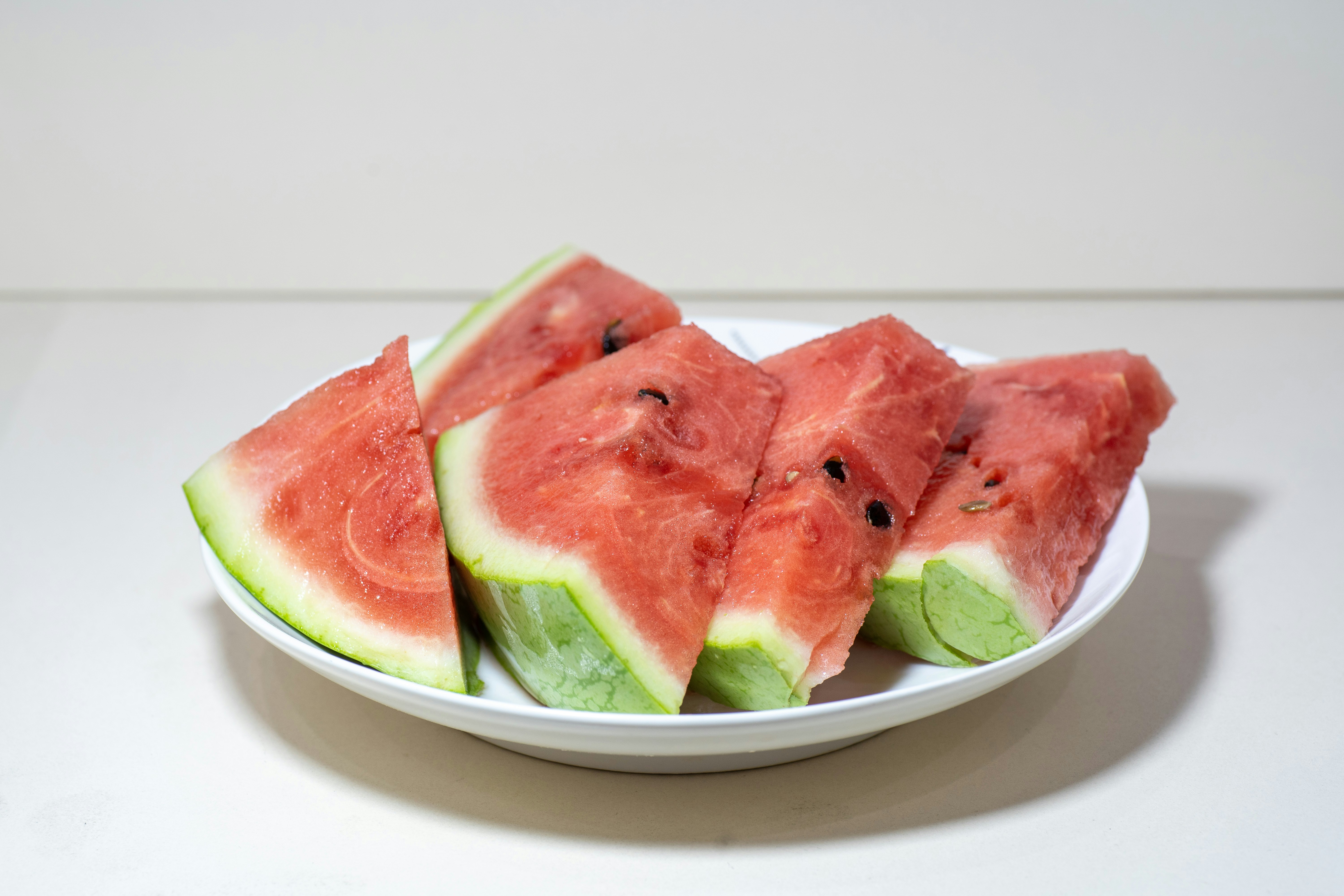 Slice Spotlight: Juicy Watermelon Crescendo on a White Plate