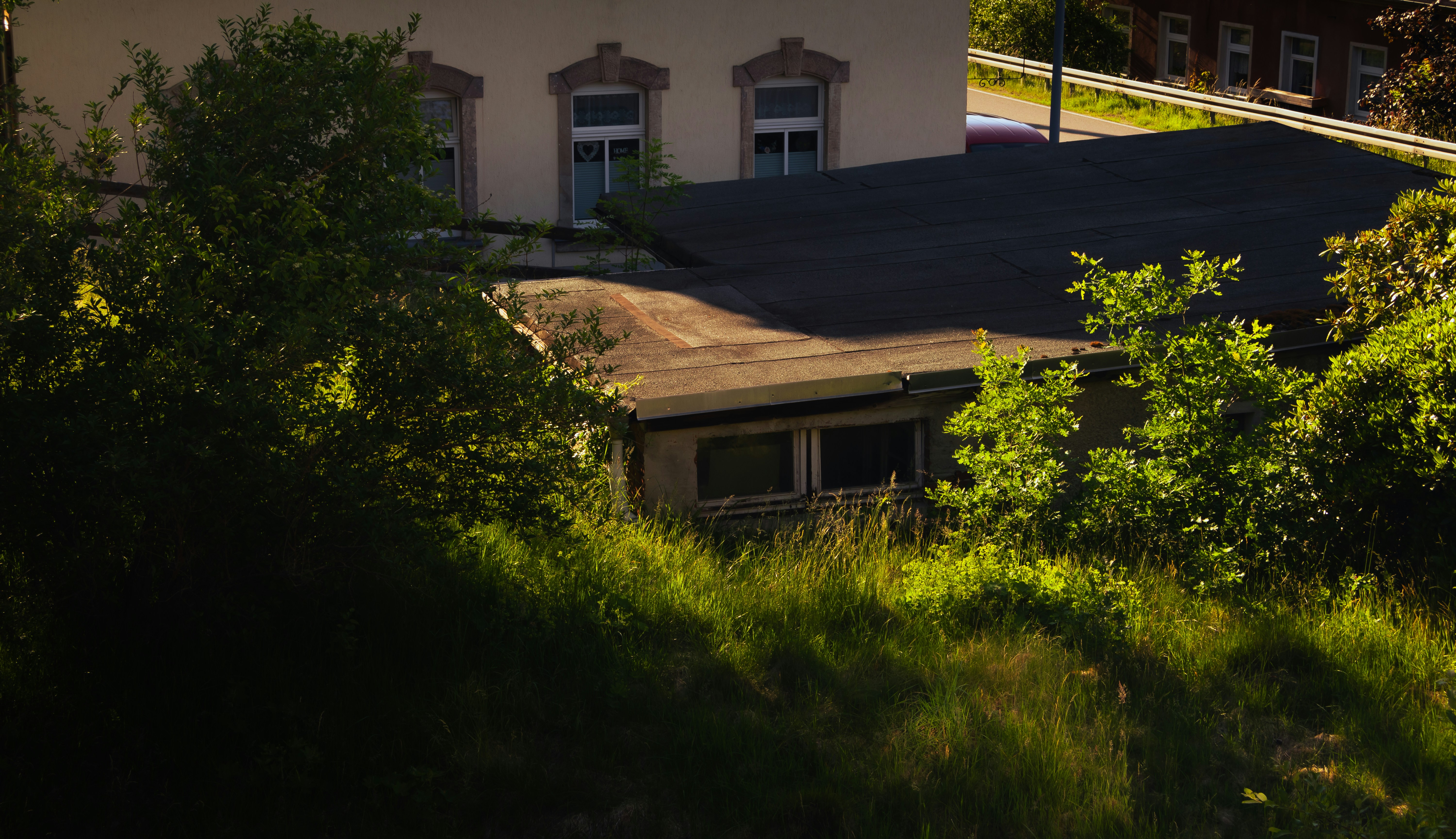 Grass and hillside overlook framing a weathered building