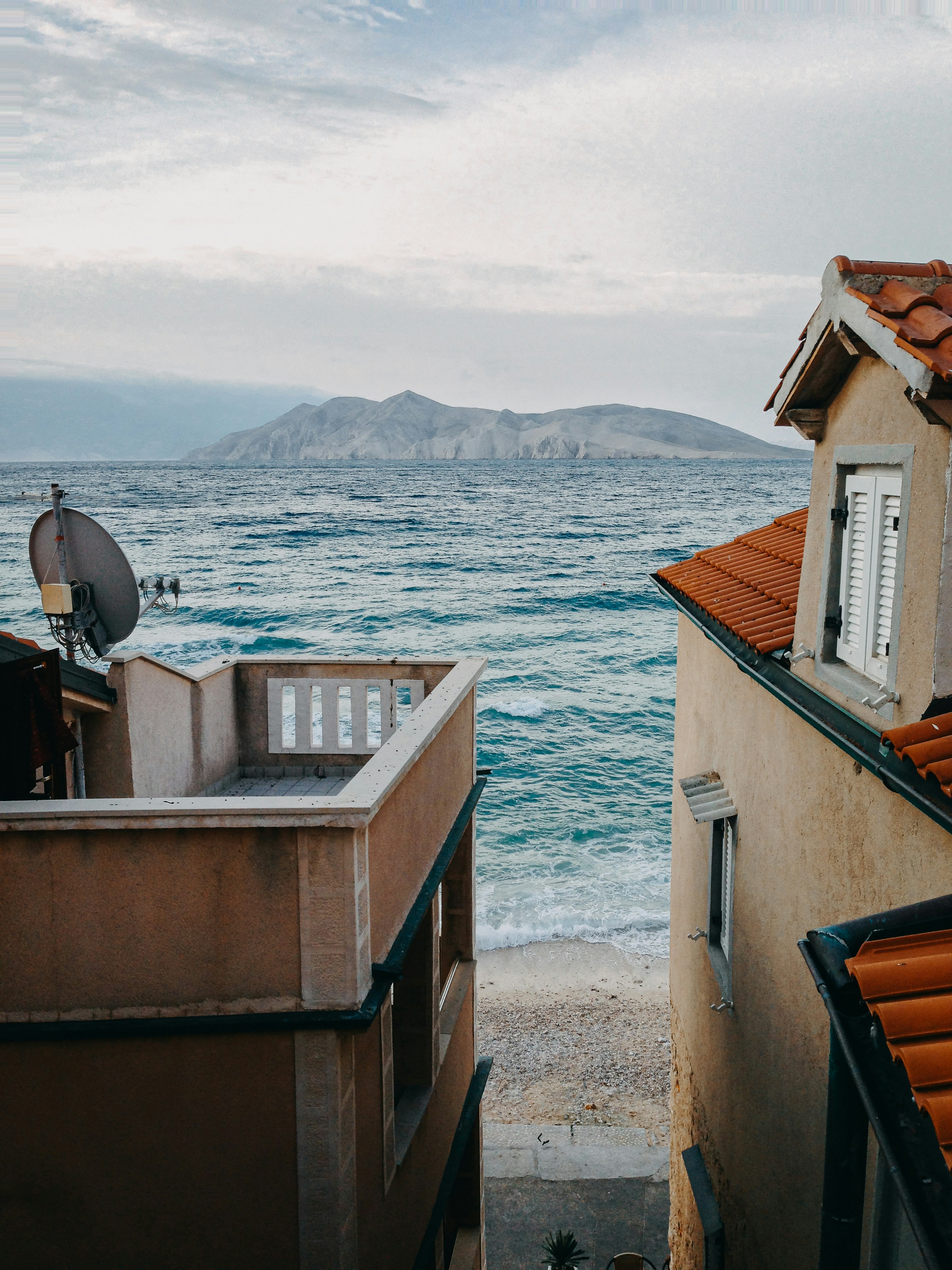 Harbor Terrace: A Narrow View Between Rooftops to the Open Sea