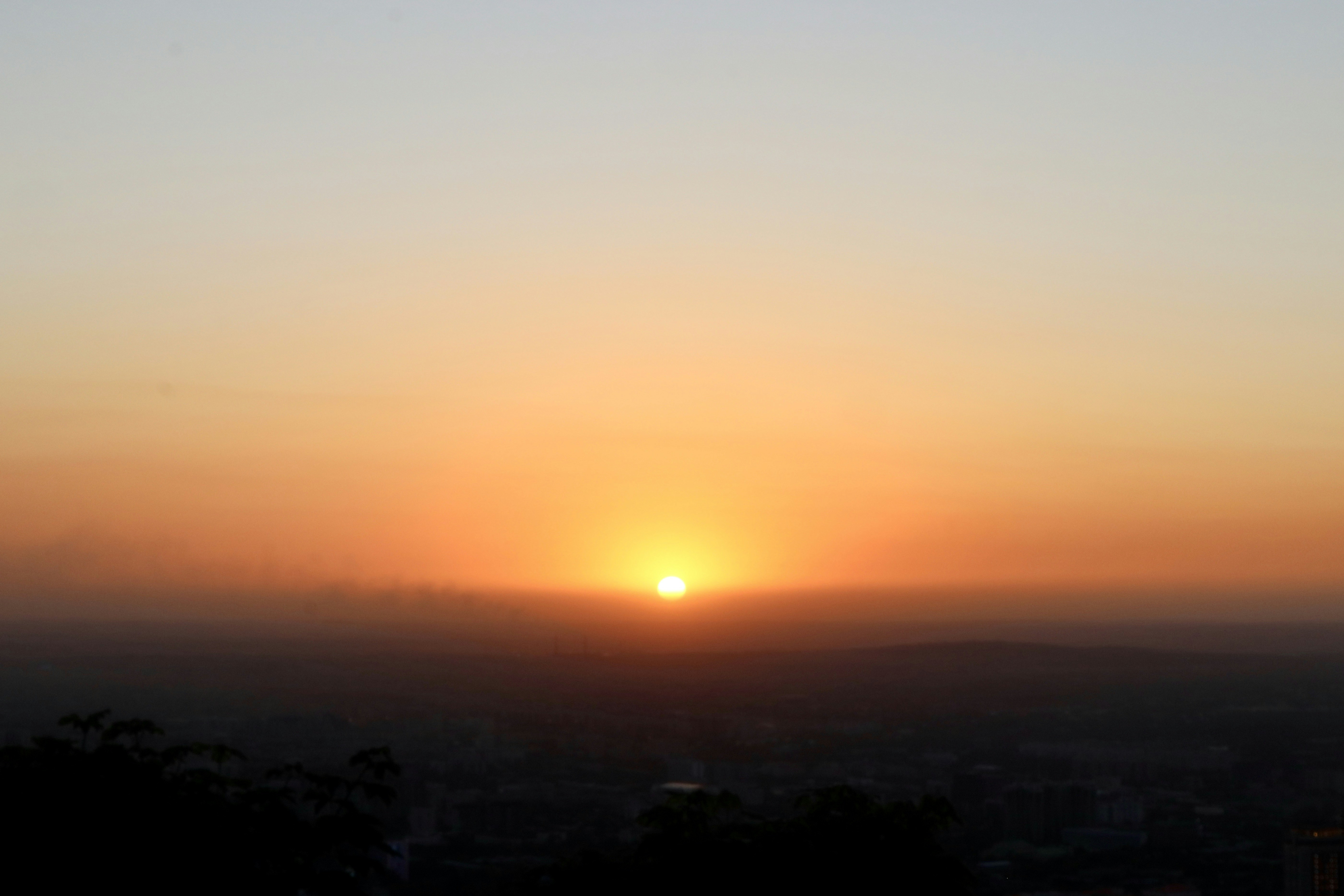 Dawn on the Horizon: Quiet Sunrise Over a Distant City