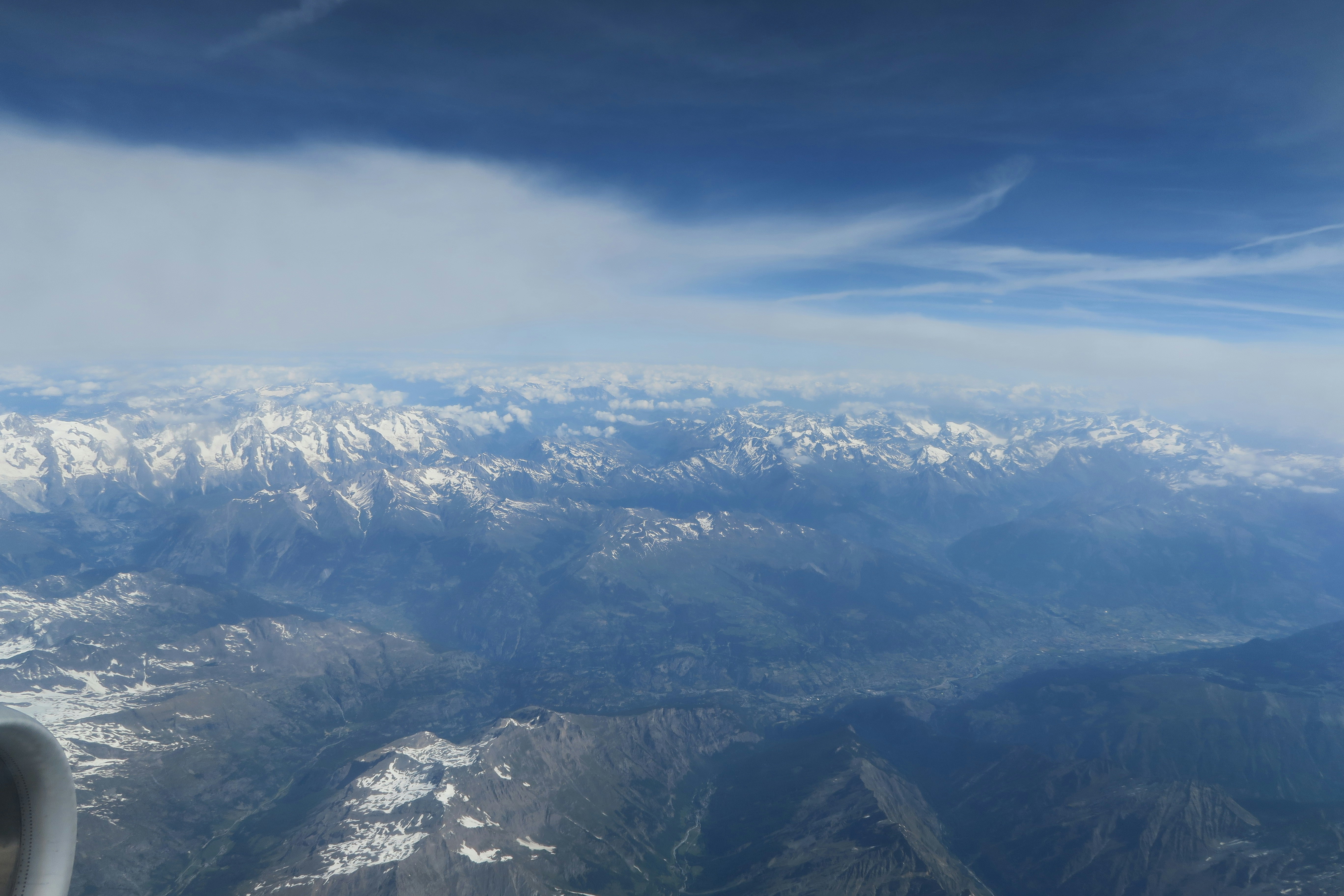 Over the Alpine Expanse: Snow-capped Ridges Beneath a Blue Cathedral