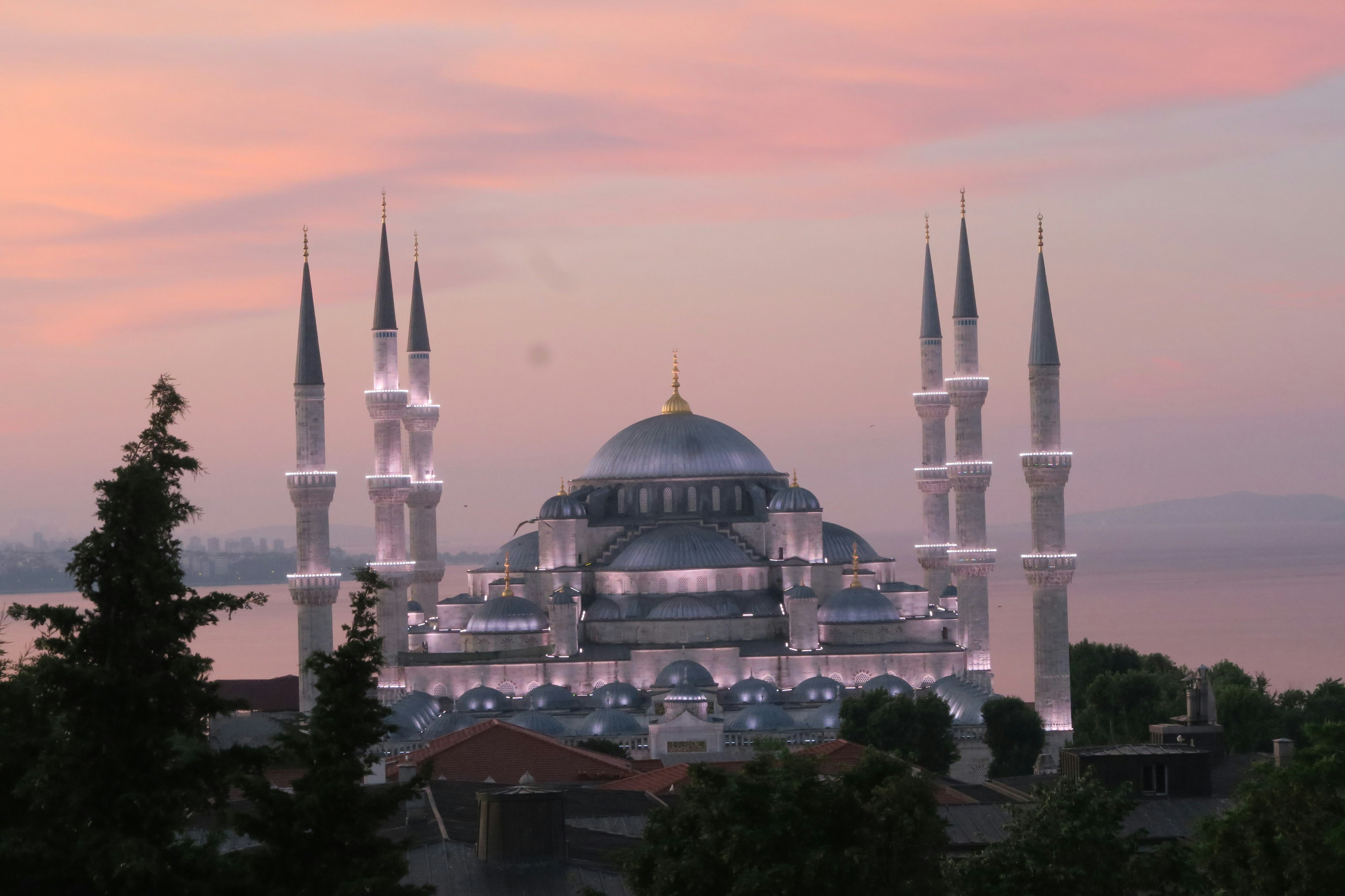 Dusky Mosque on the Horizon: Minarets Framing a Silver Dome