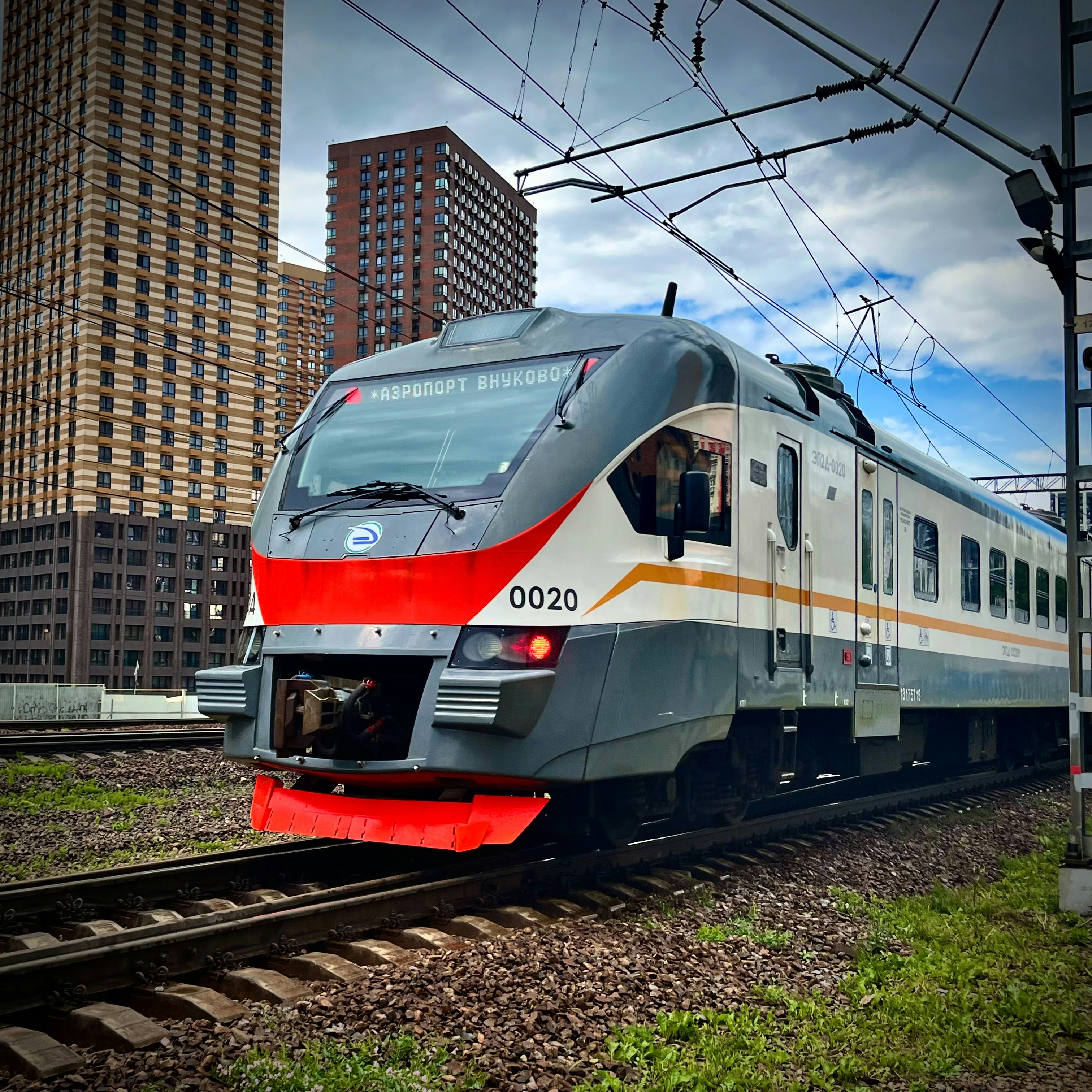 Racing Rails: A Modern Electric Train Surges Through Urban Rails