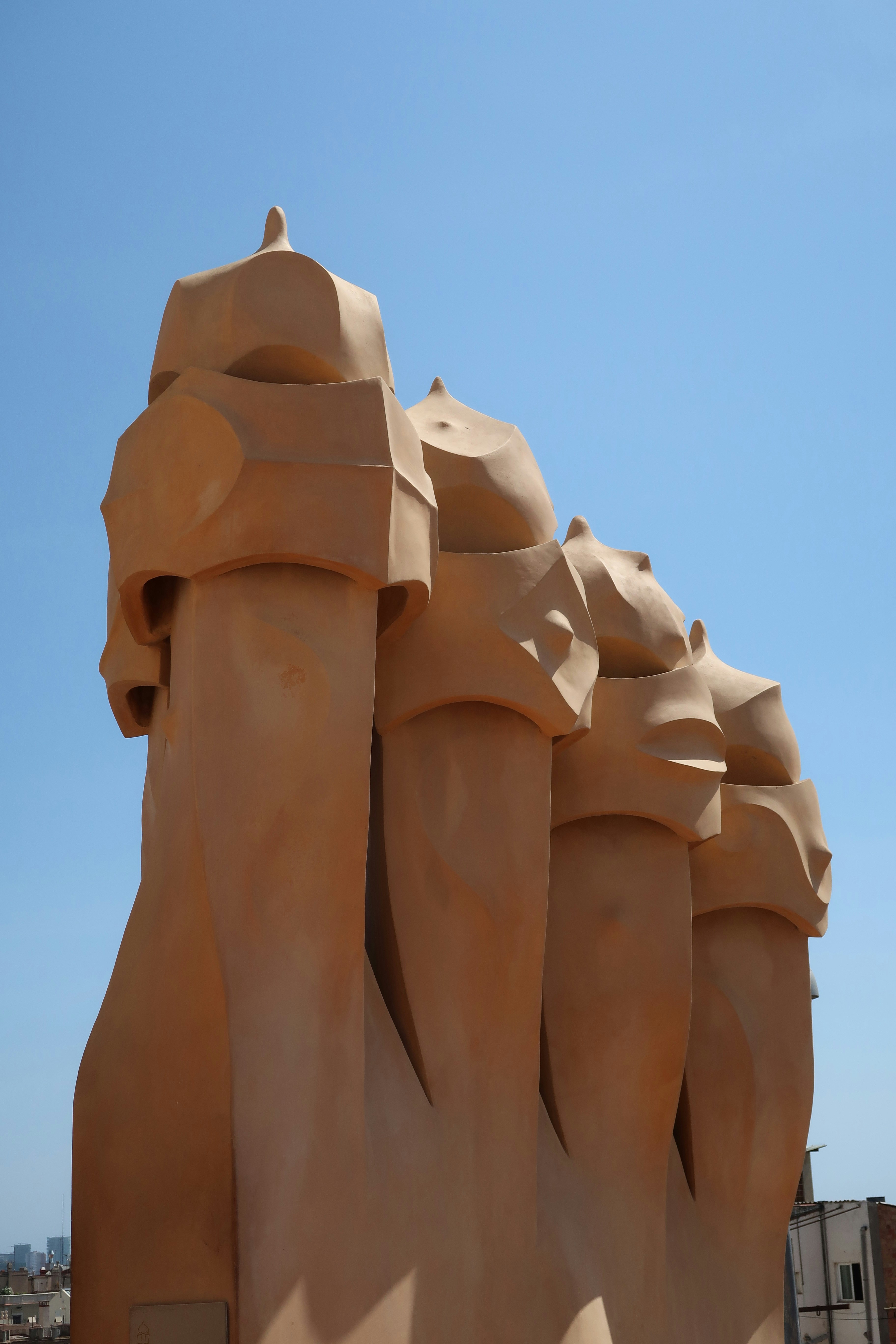Fantastical chimneys of warm-clay towers leaning toward the blue sky