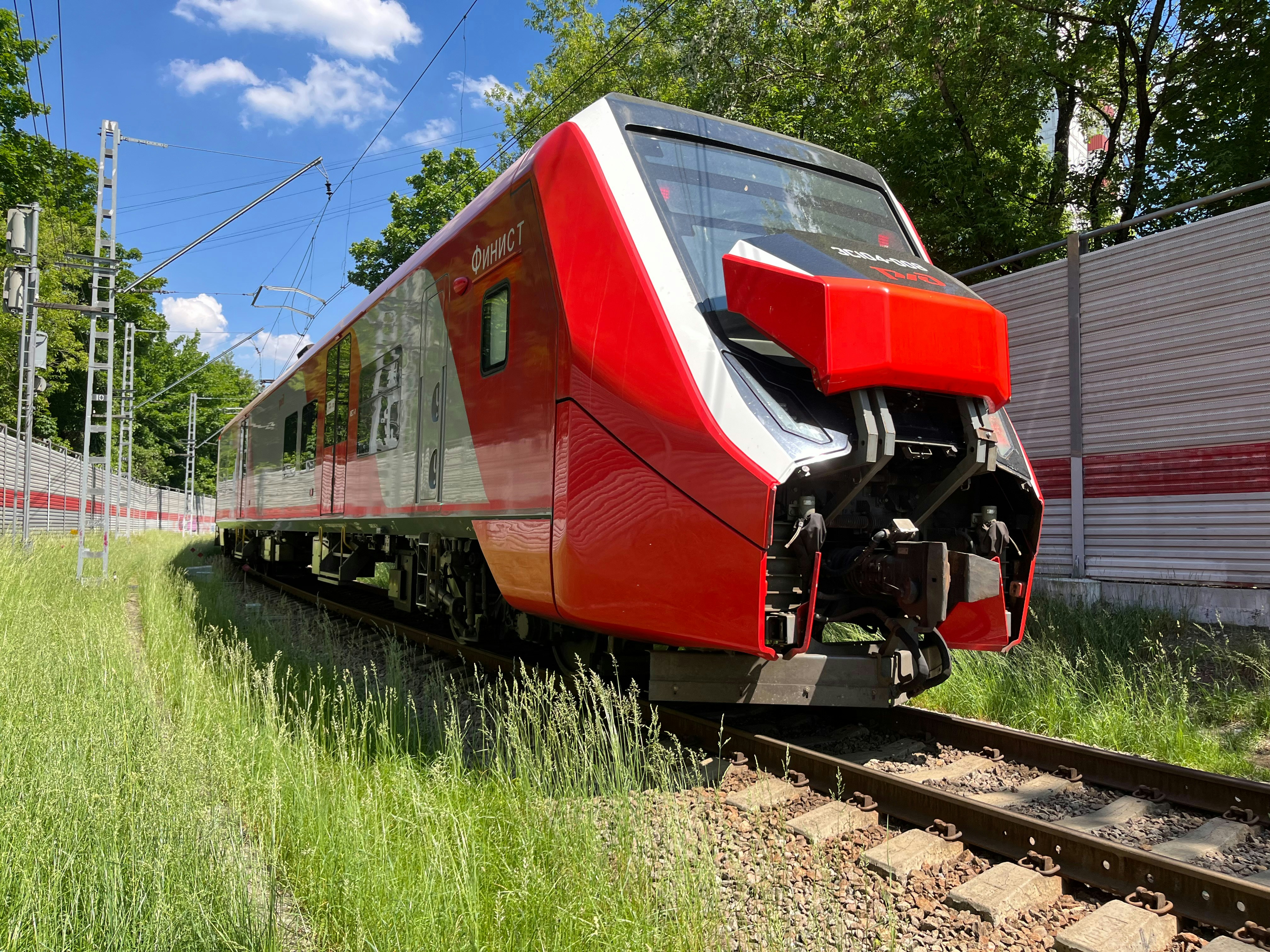 Red Intercity Gleam: A Forward-Facing Train on a Sunny Railline