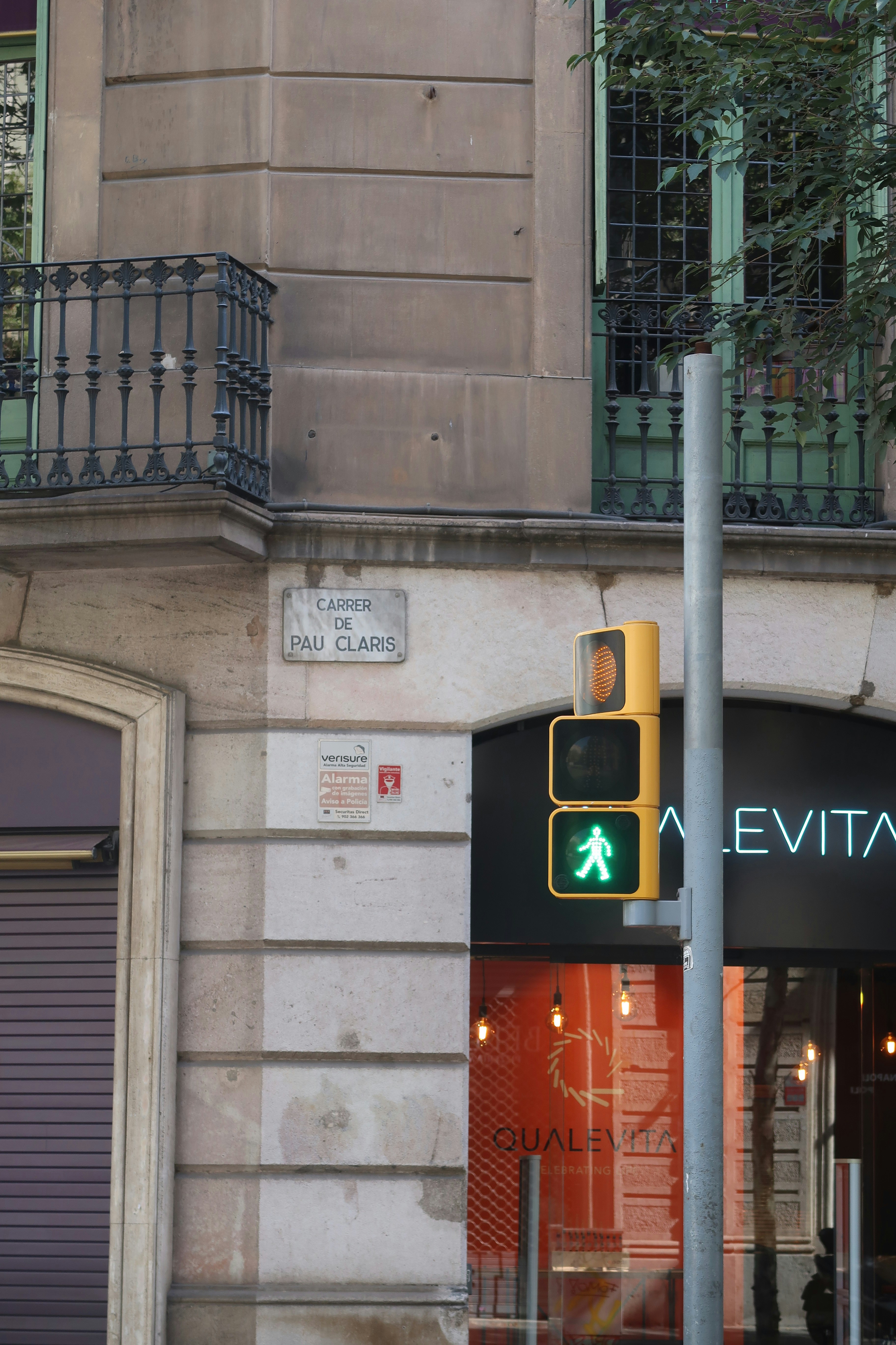 Green Light at a Parisian Corner with Storefront Glow