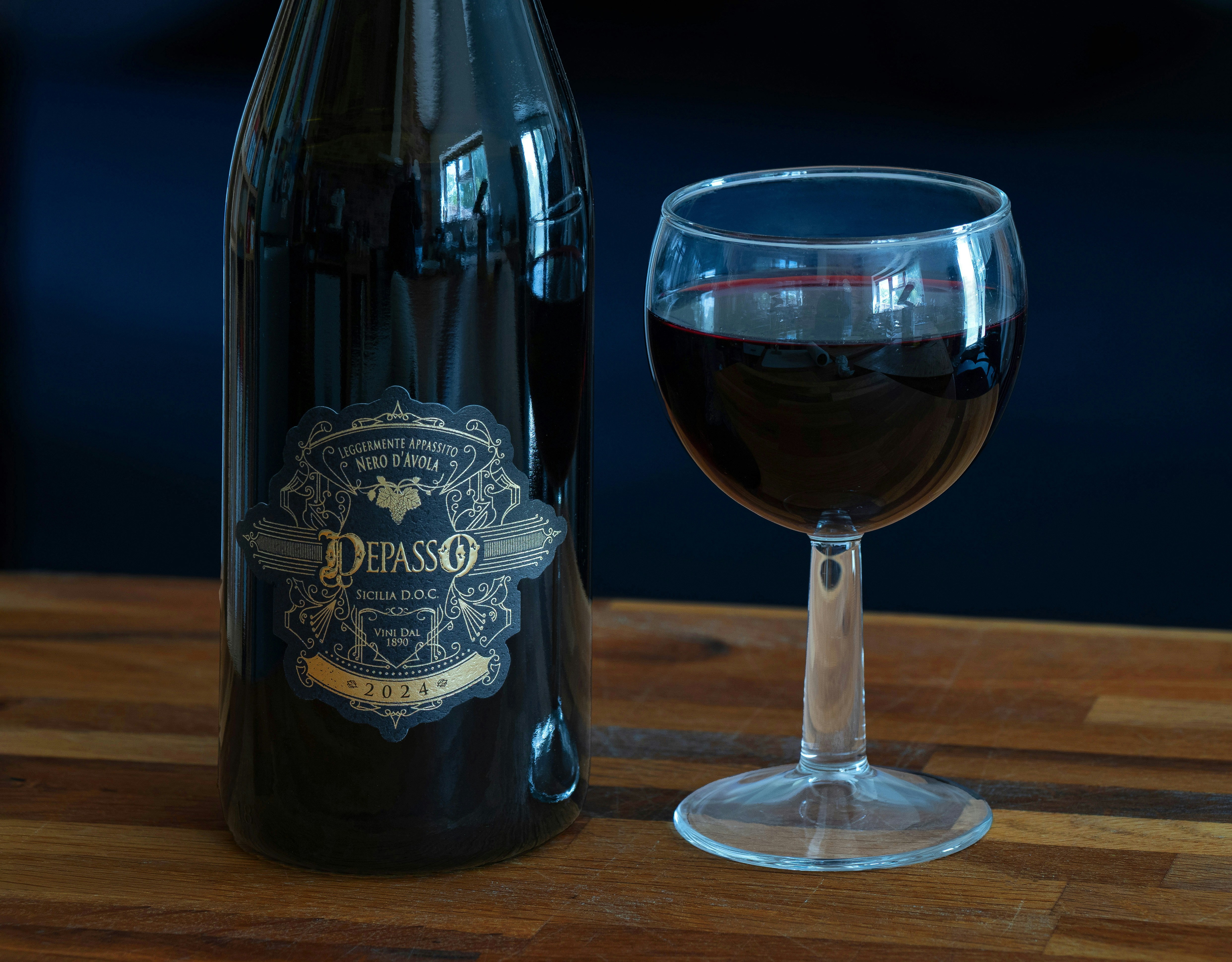 Amber Night: A Bottle and Glass on a Wooden Stage