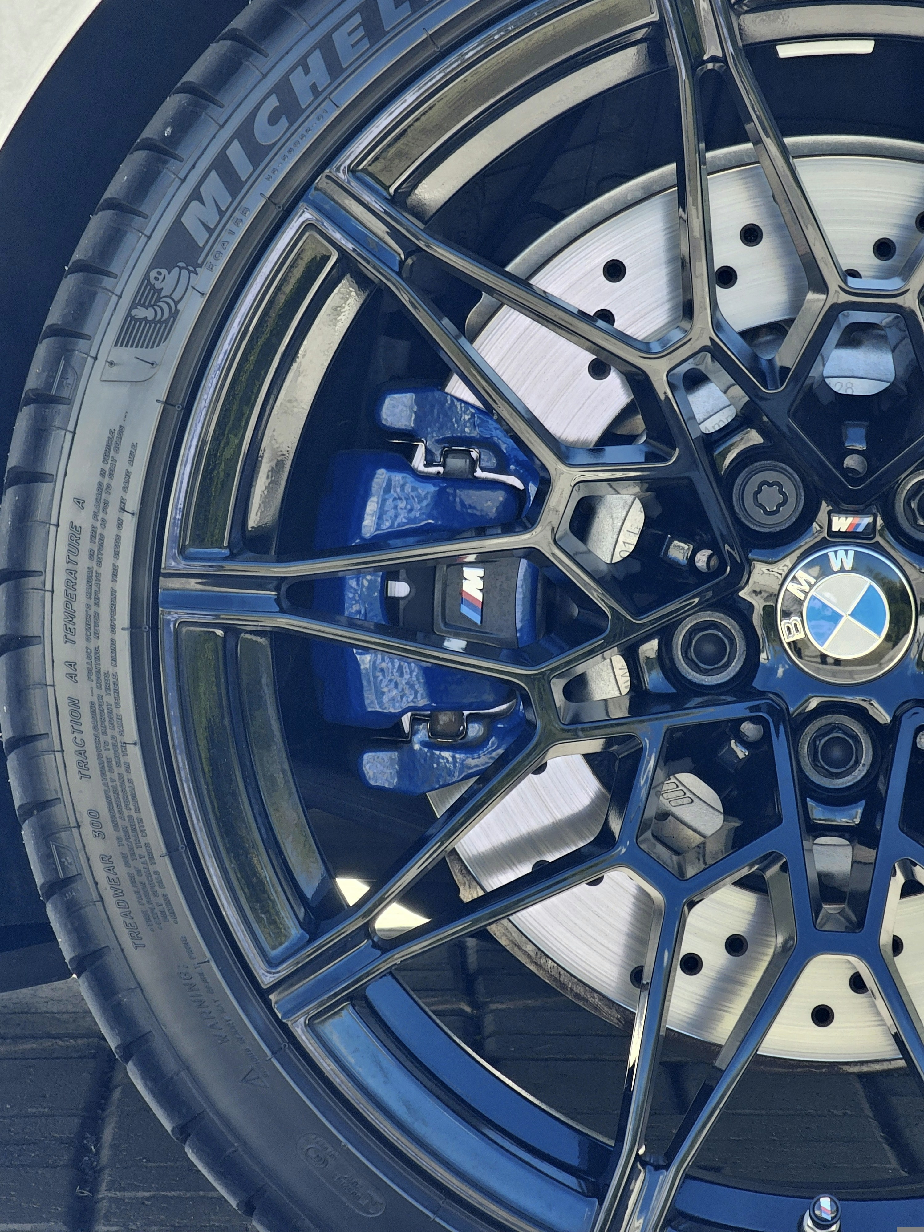 Blue M-tuned Precision: A BMW wheel and brake in motion