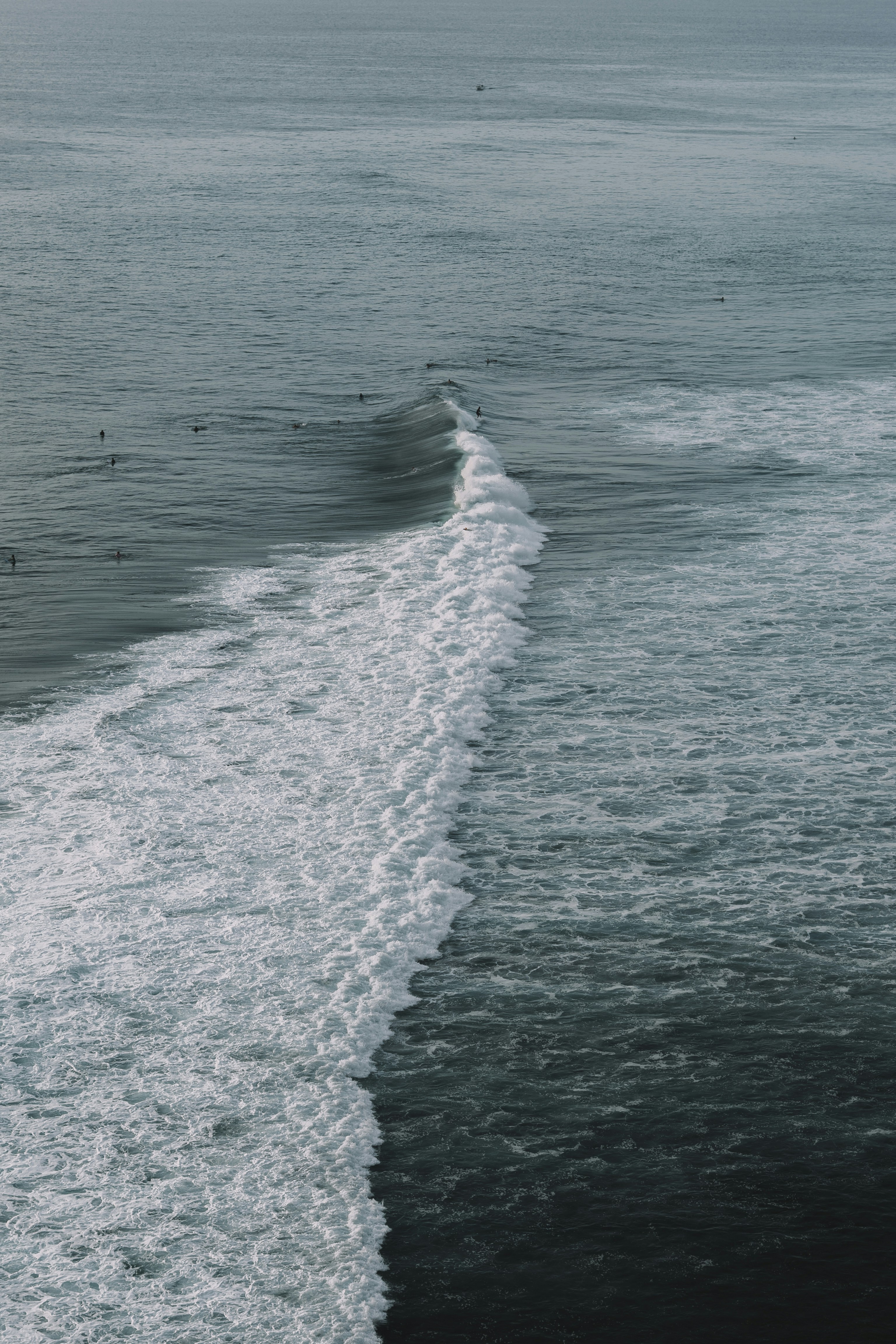 Line of Crest: A lone surfer's path traced by a breaking wave