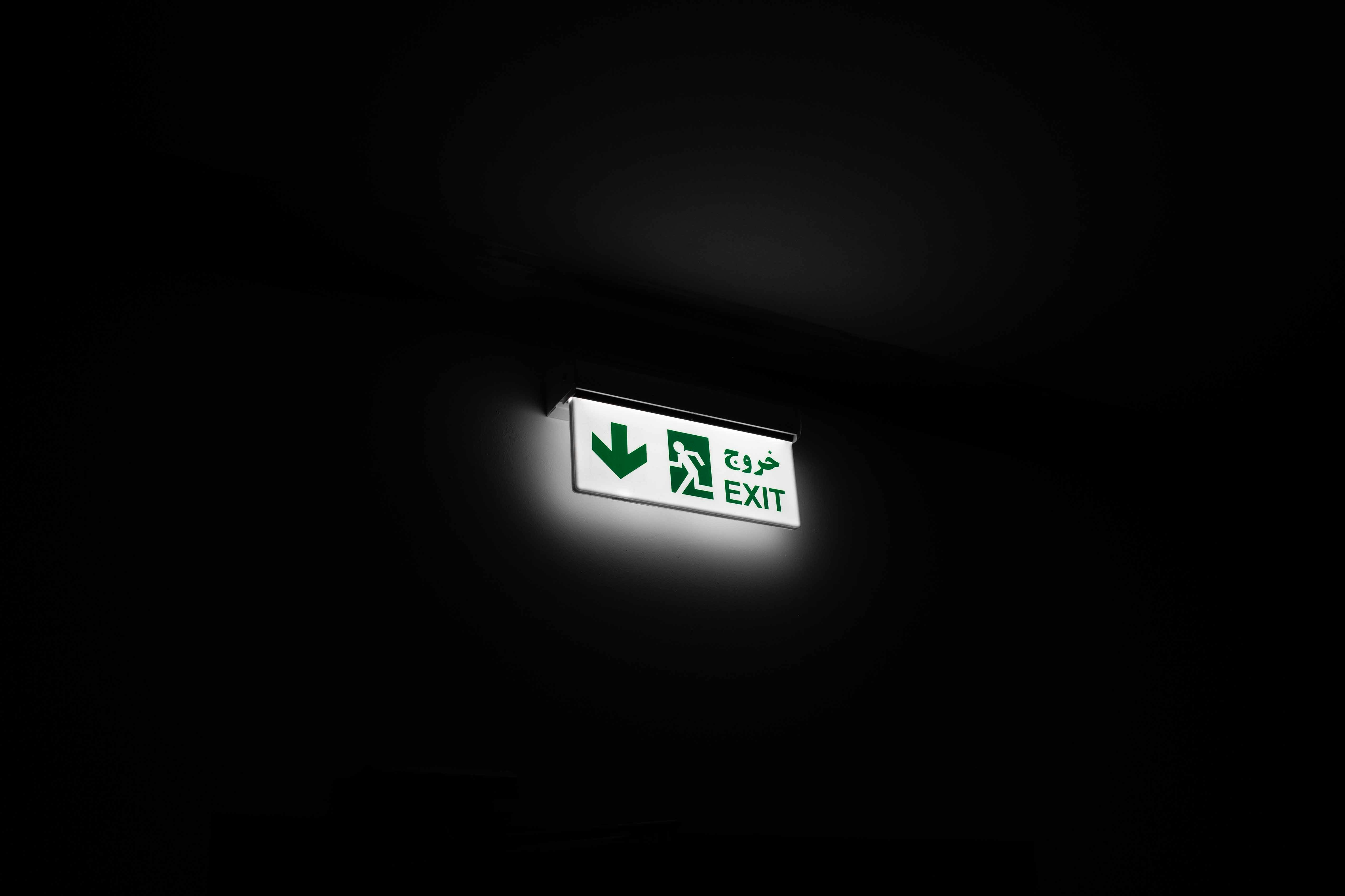 Glowing Exit Sign in a Dark Corridor
