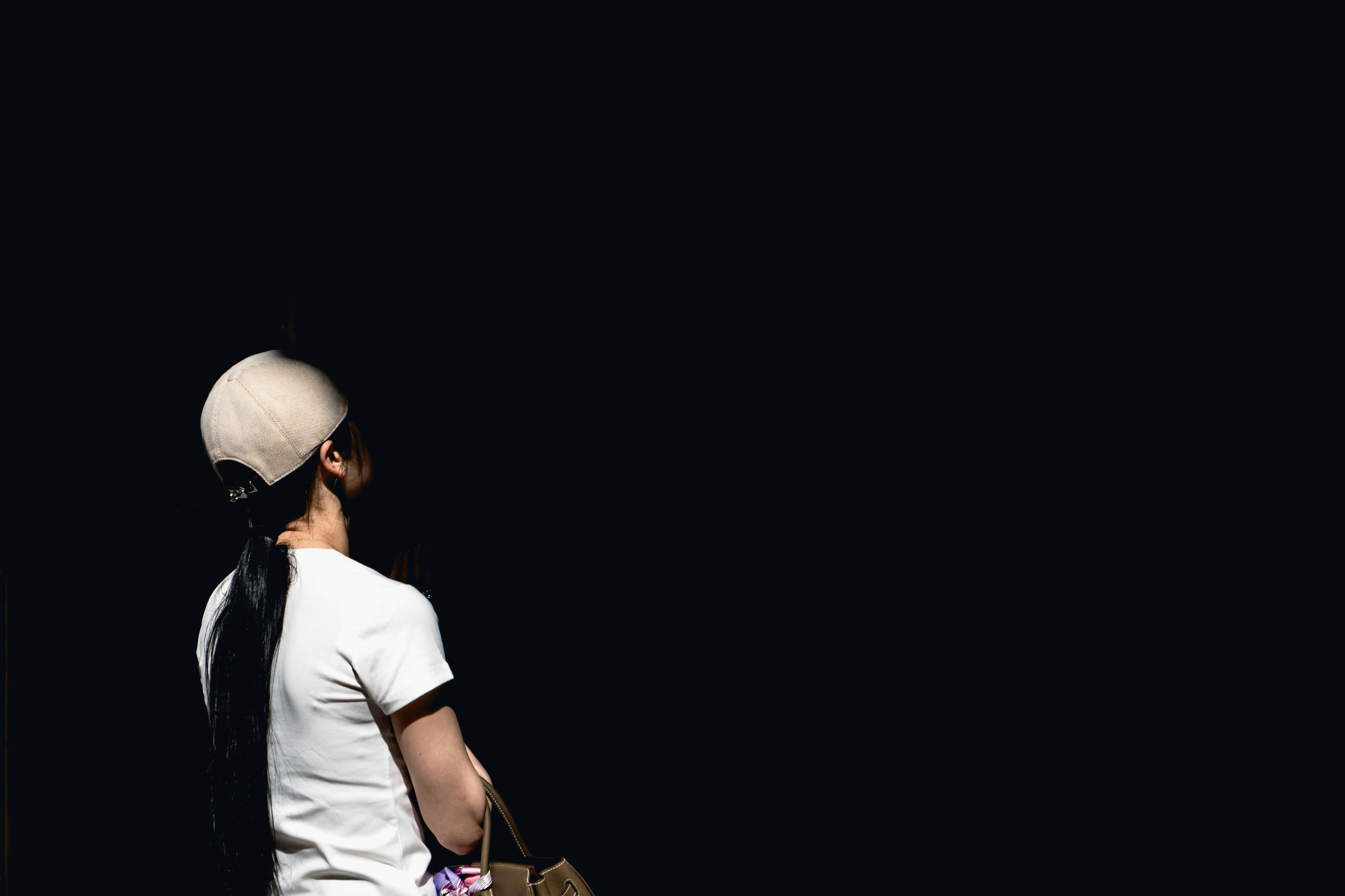 Left-Edge Shopper: A Quiet Portrait in a Dark Studio