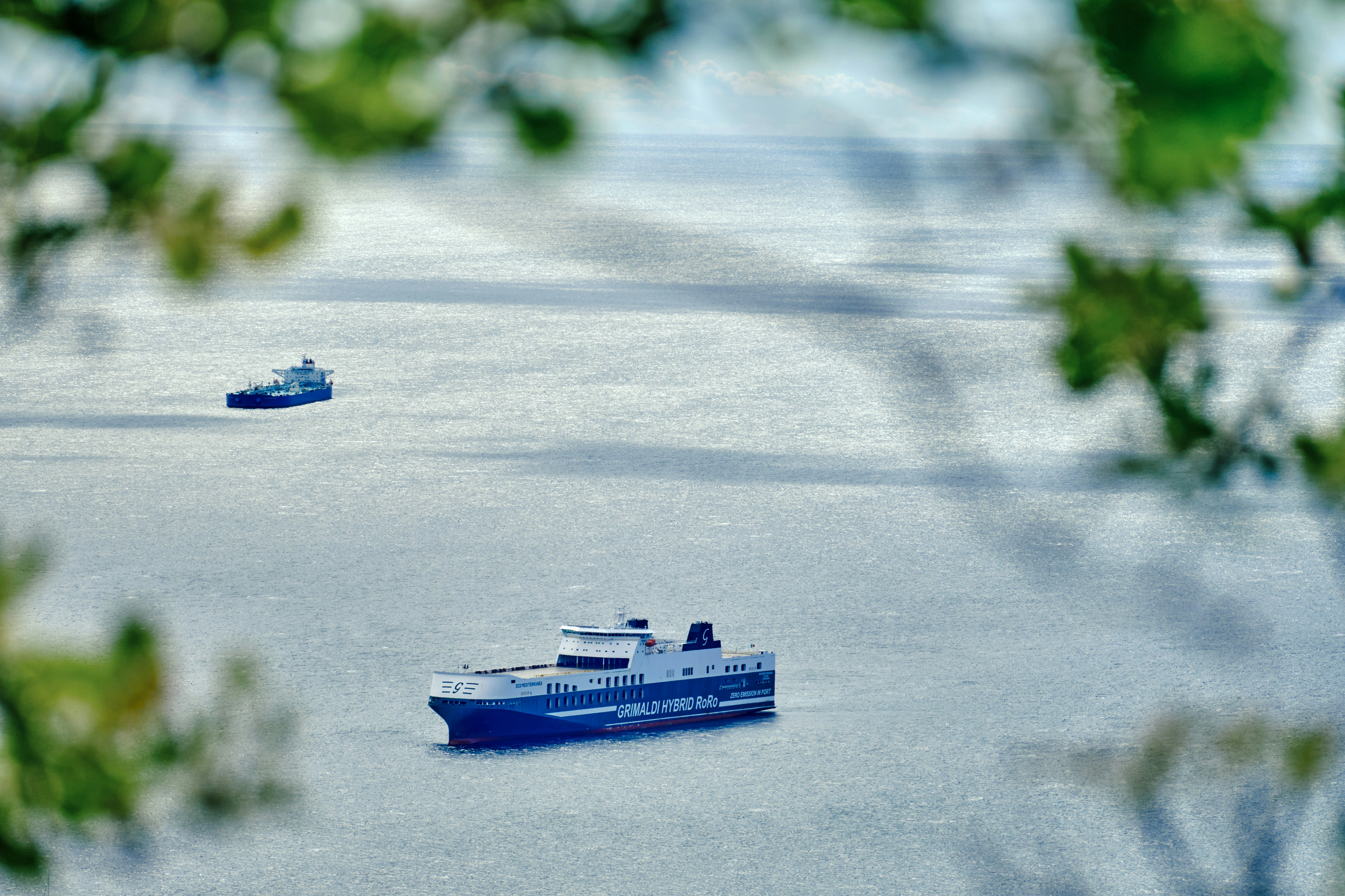 Coastal Distant Carriers: Ships Anchored in Afternoon Light