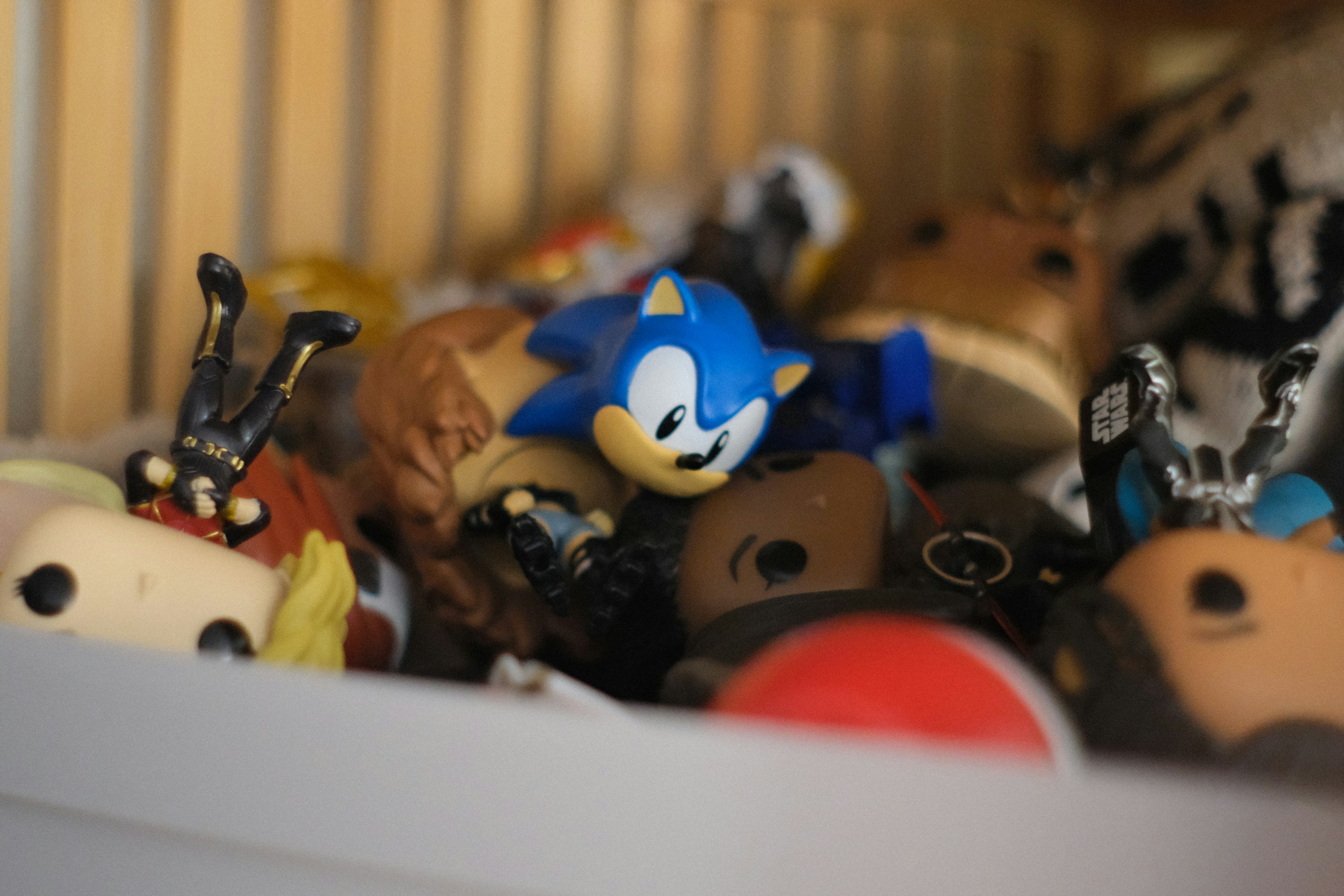 Blue Sonic Toy Surrounded by Plush Companions