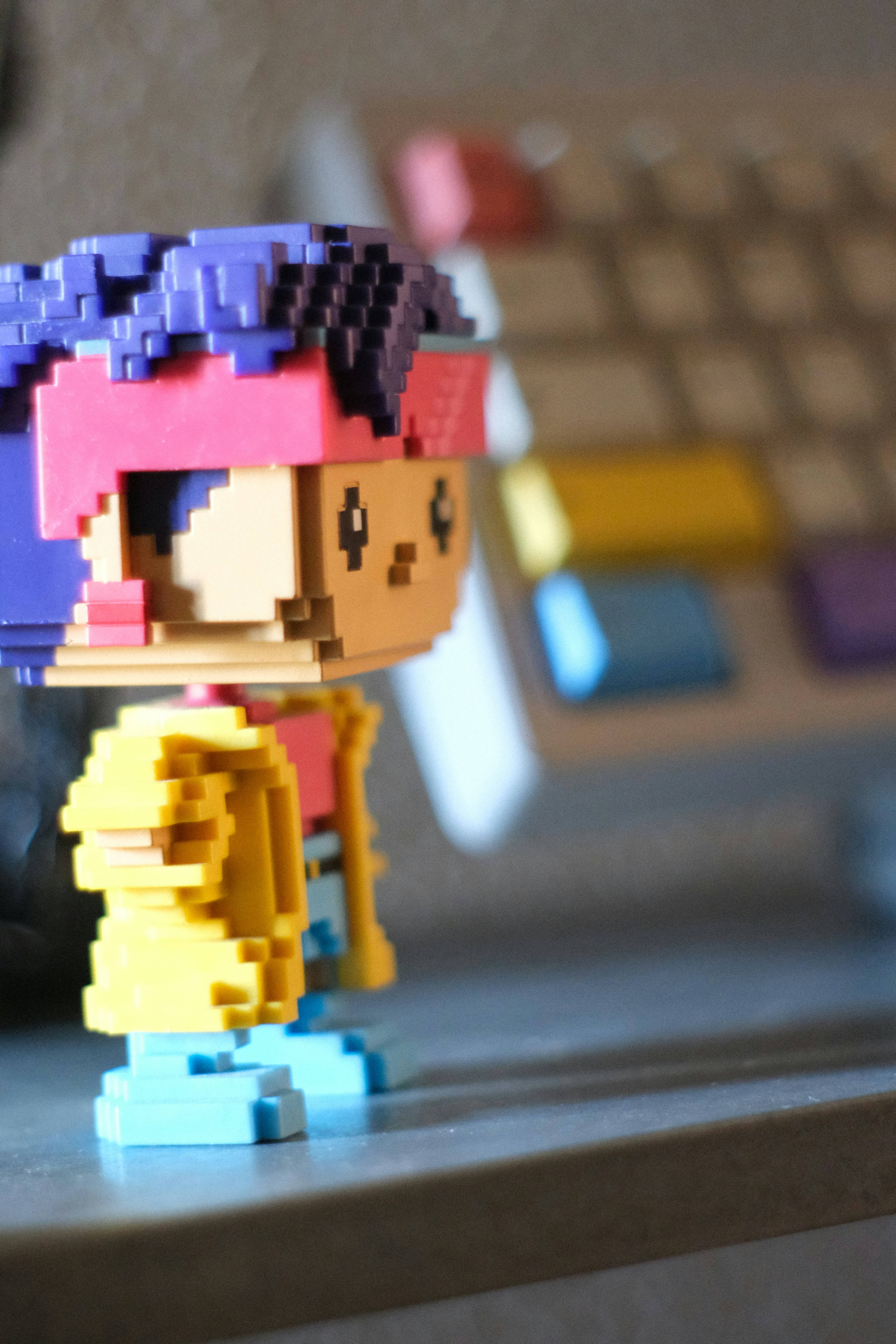 Pixelated Hero: A Blocky Figure Stares Down the Desk Edge