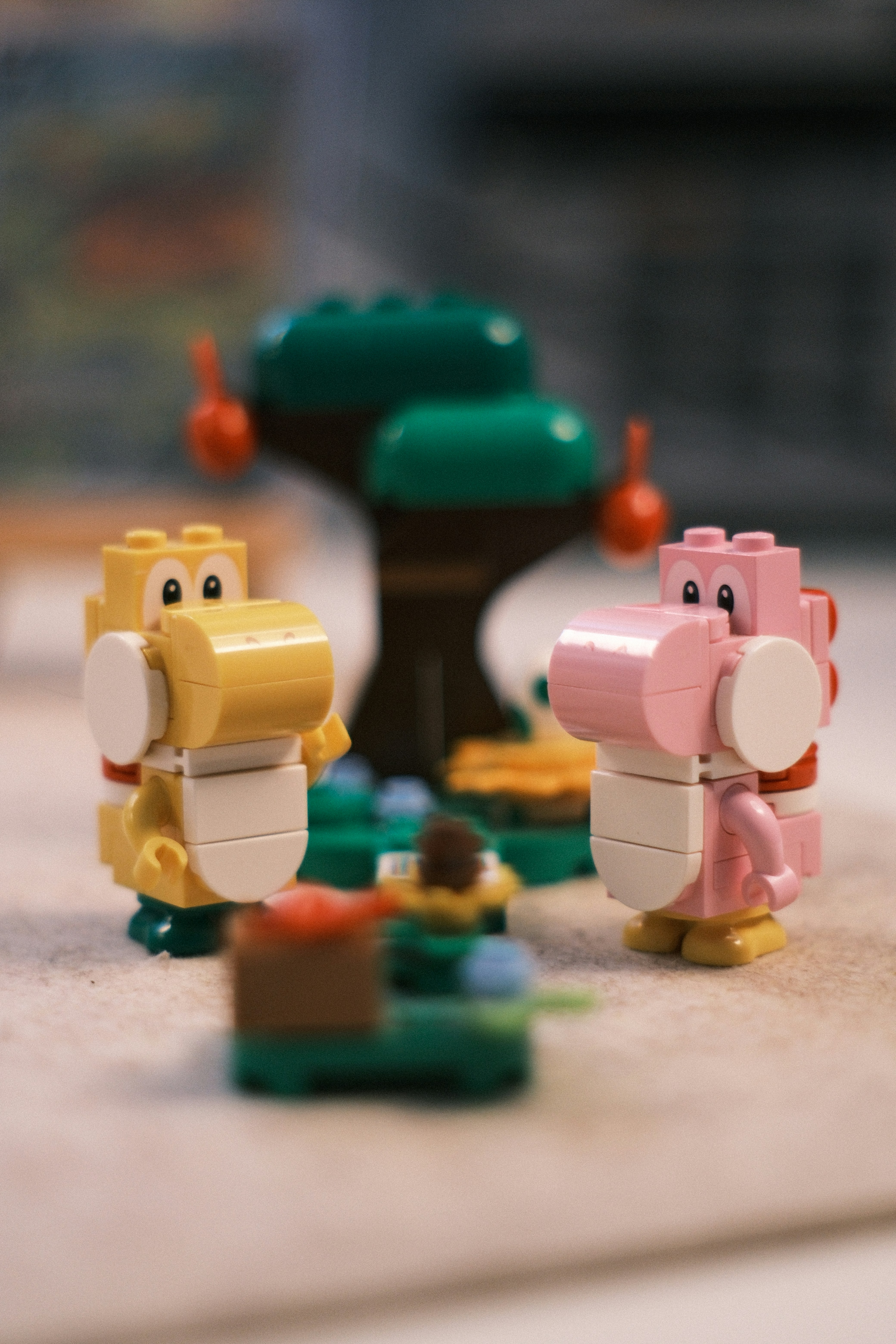 Two Lego hippos face off in a sunlit toy village