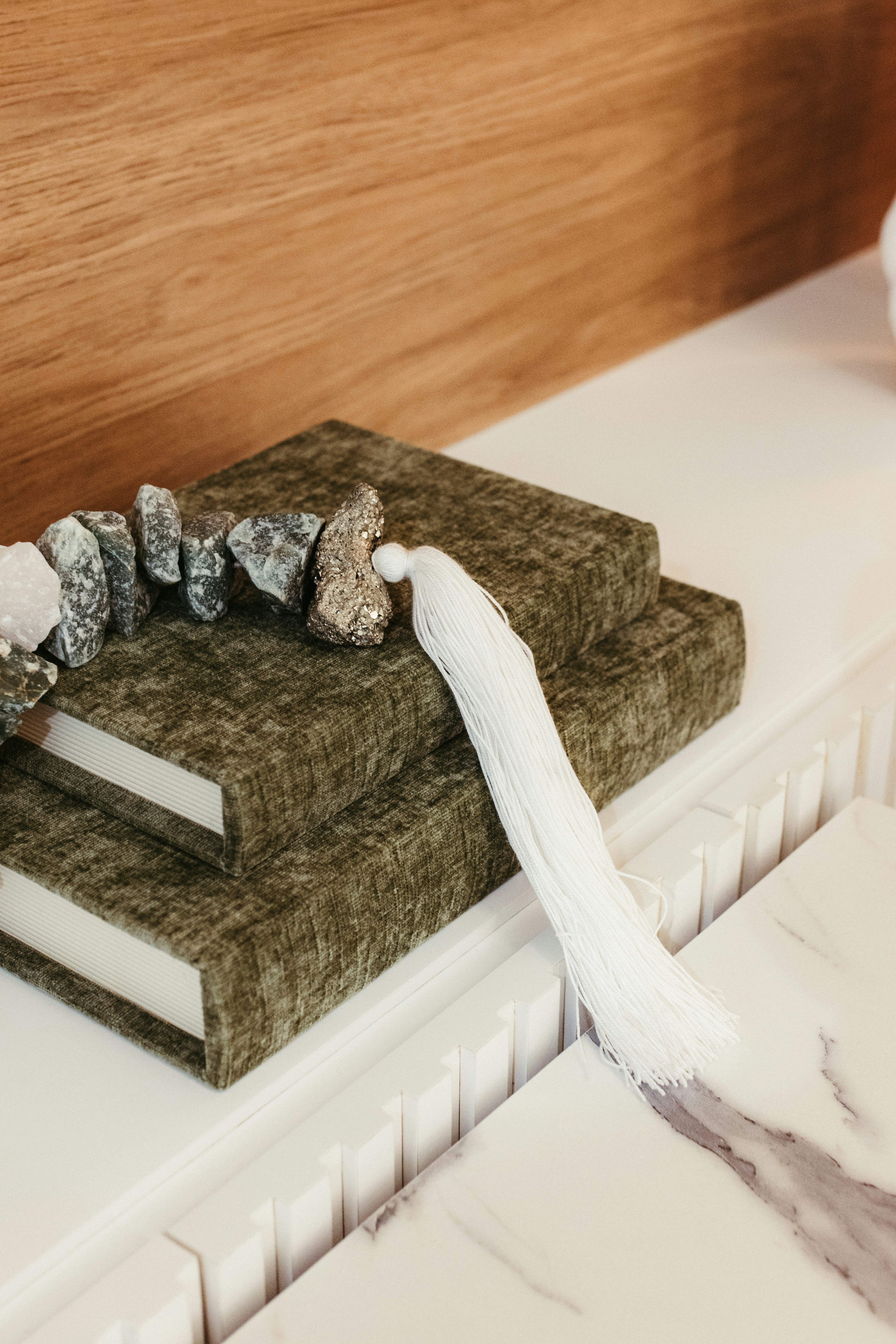 Pebbled ornament resting on layered textiles atop a marble-topped surface