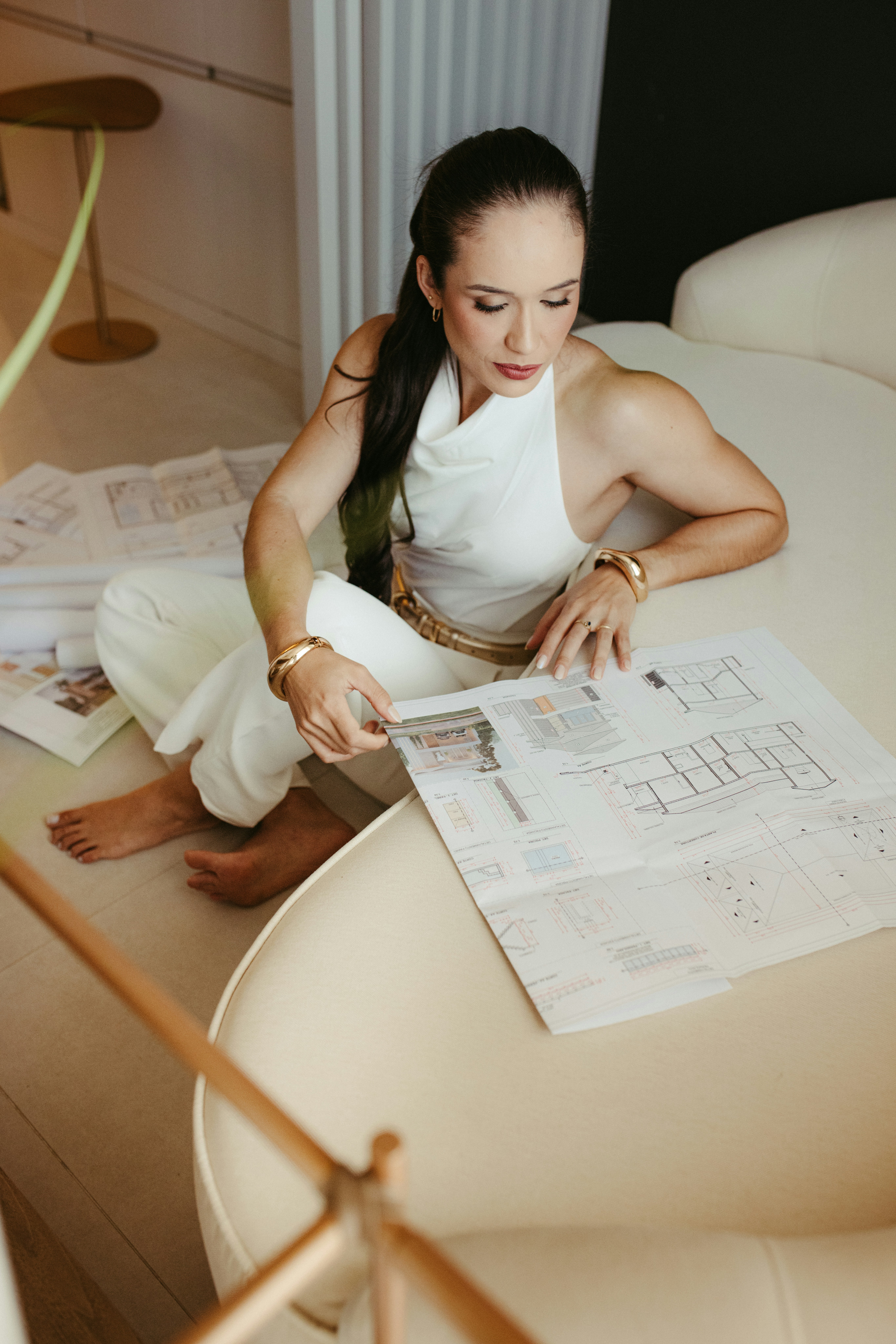 Architect of Light: A Woman Studies Plans in Soft Interior Glow