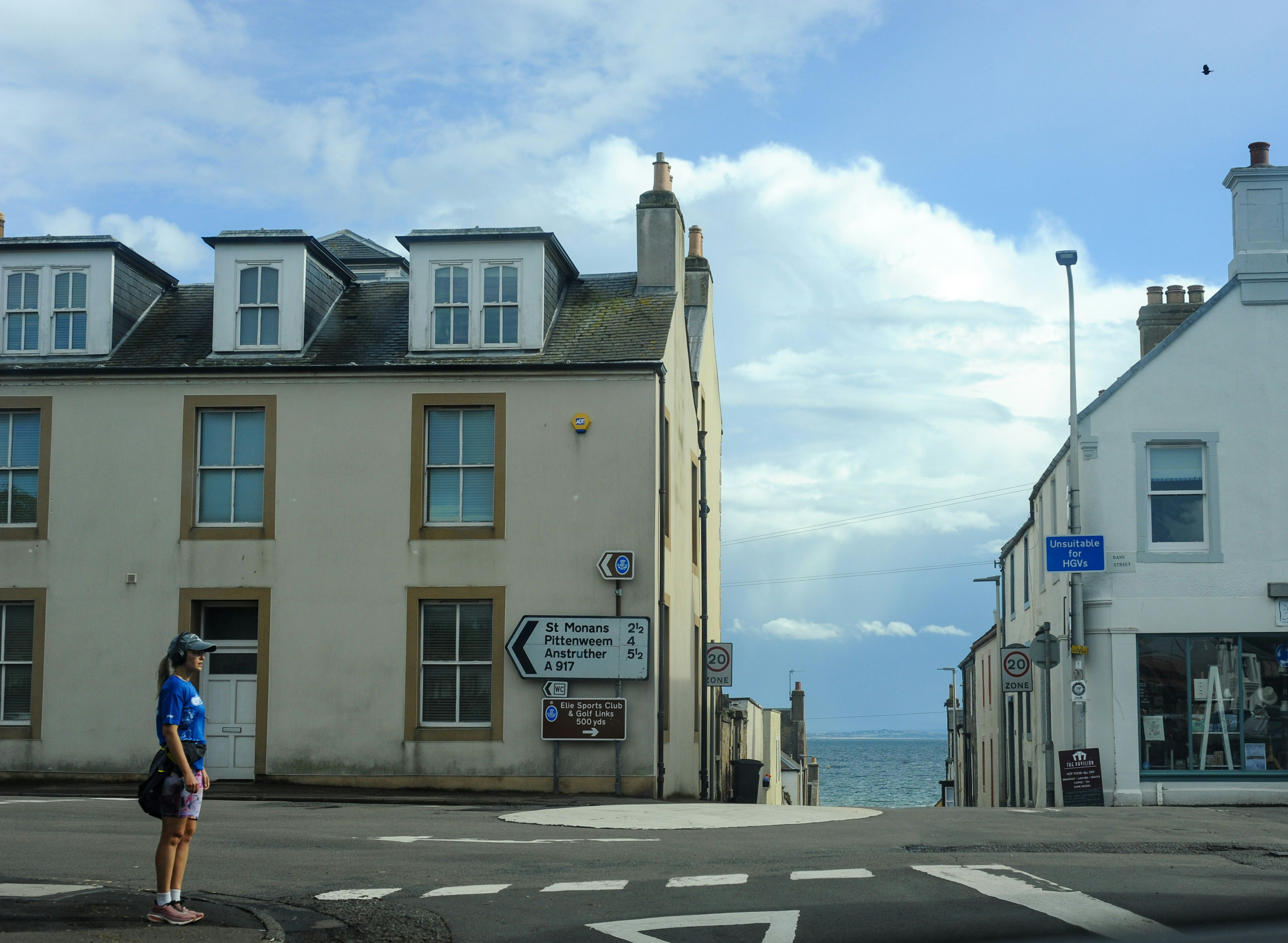 Lighthouse Gap: A Seaside Street Framed by Distant Ocean Light