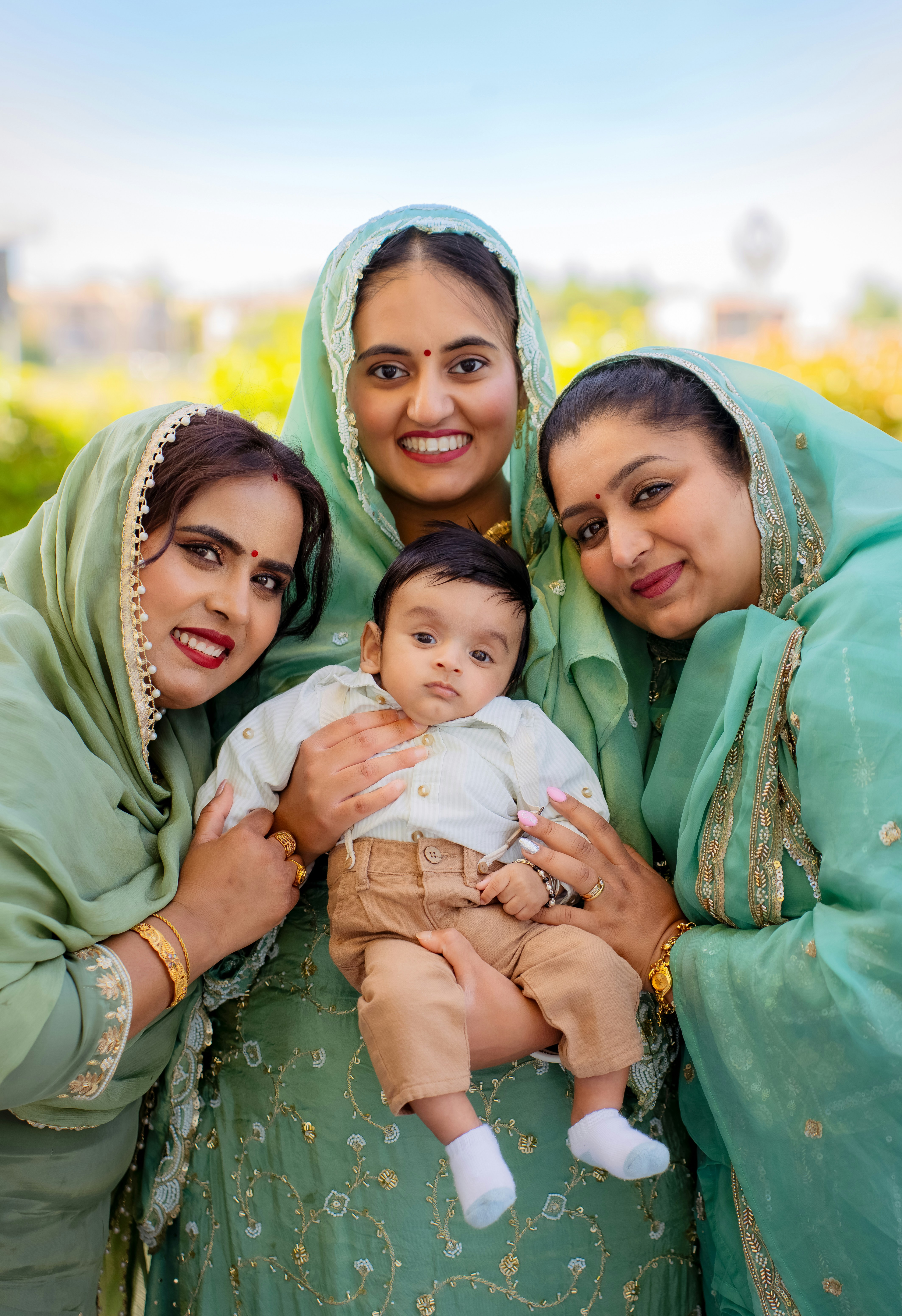 Family in Mint-Teal: A Mother's Embrace with Baby