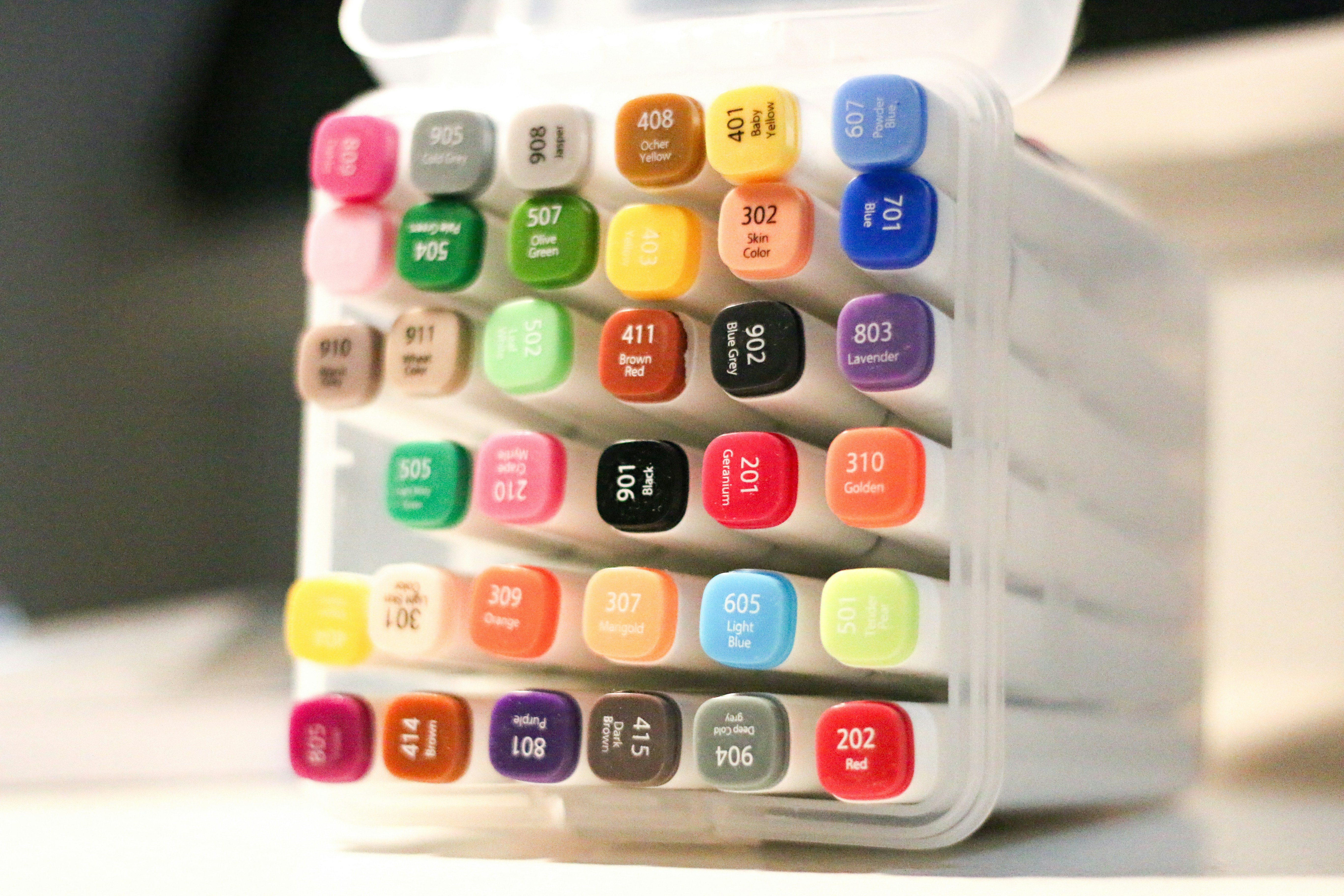 Palette of Pigments in a Stacked Case: A Close-Up on Colorful Marker Caps