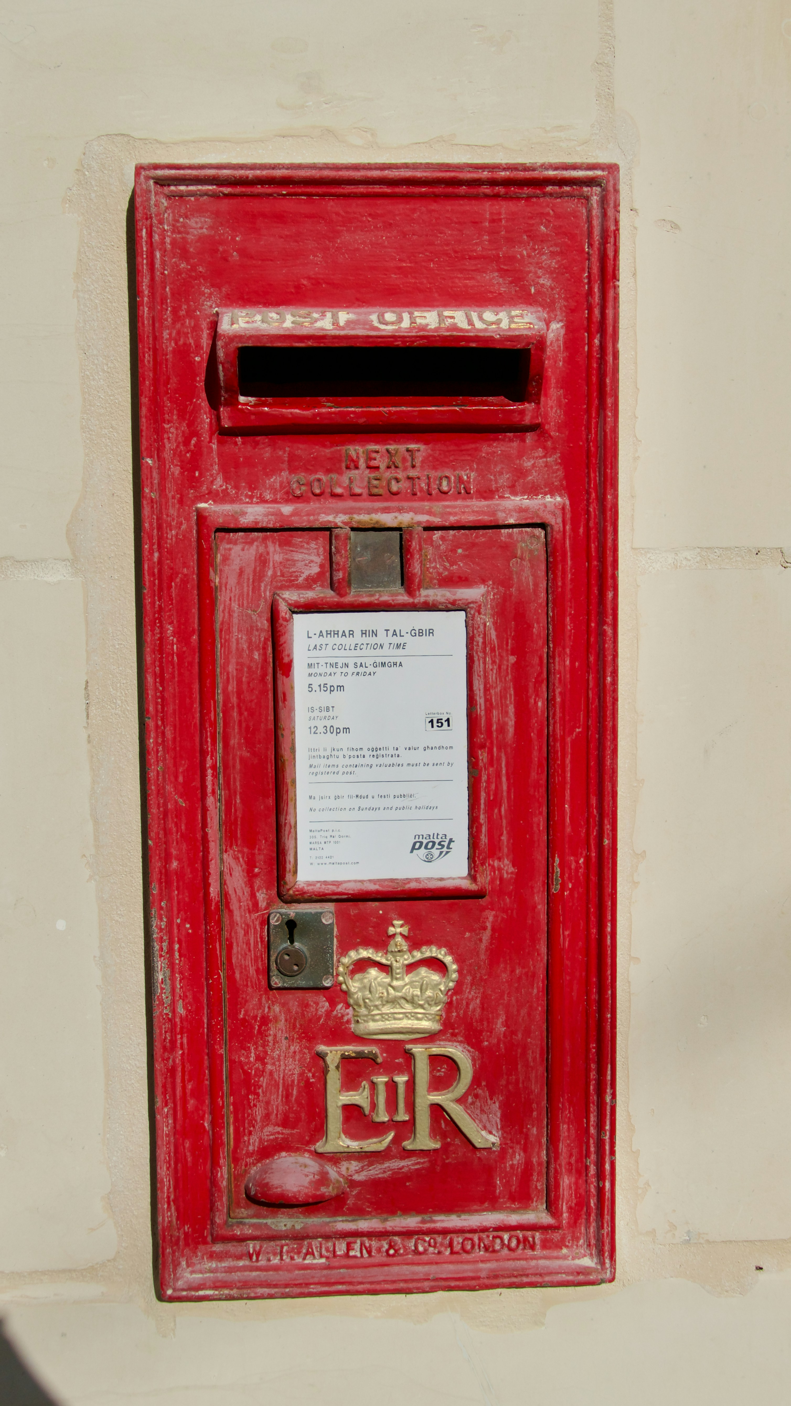 Crimson Royal Mail: A Weathered Red Mailbox Standing Bold
