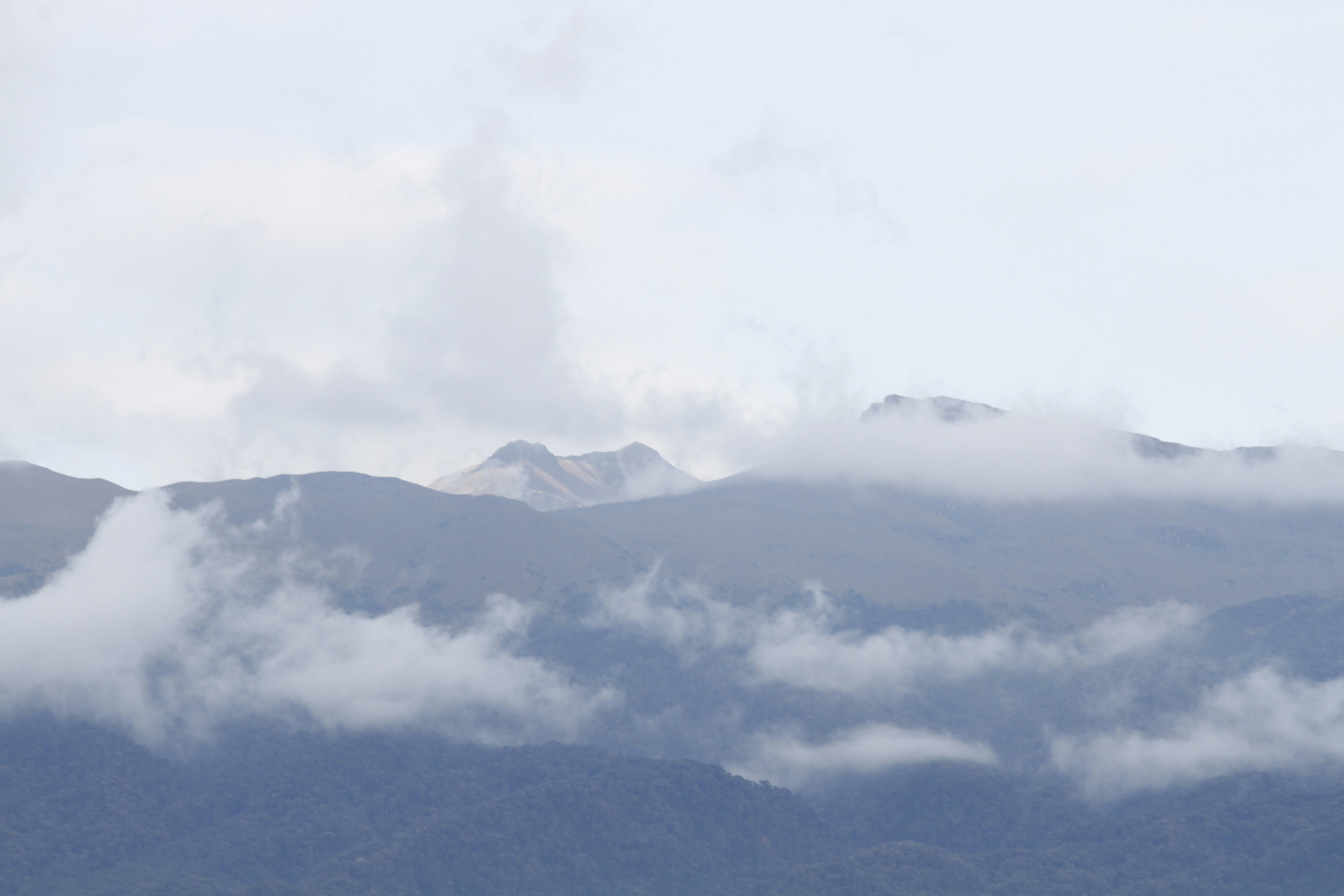 Mist-veiled summits above a tranquil ridge