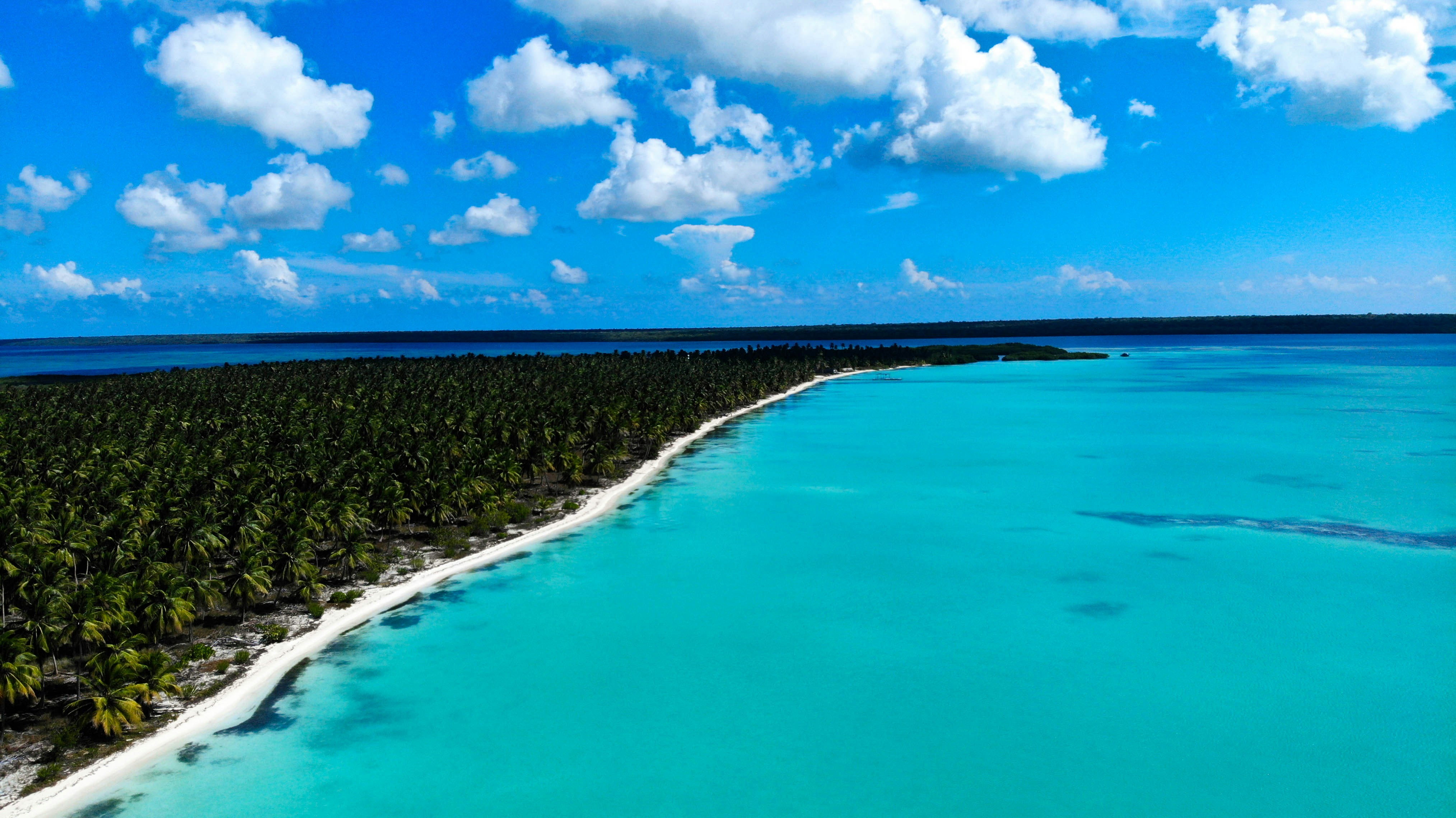Tropical island with white beach, turquoise ocean, and blue sky. photo ...