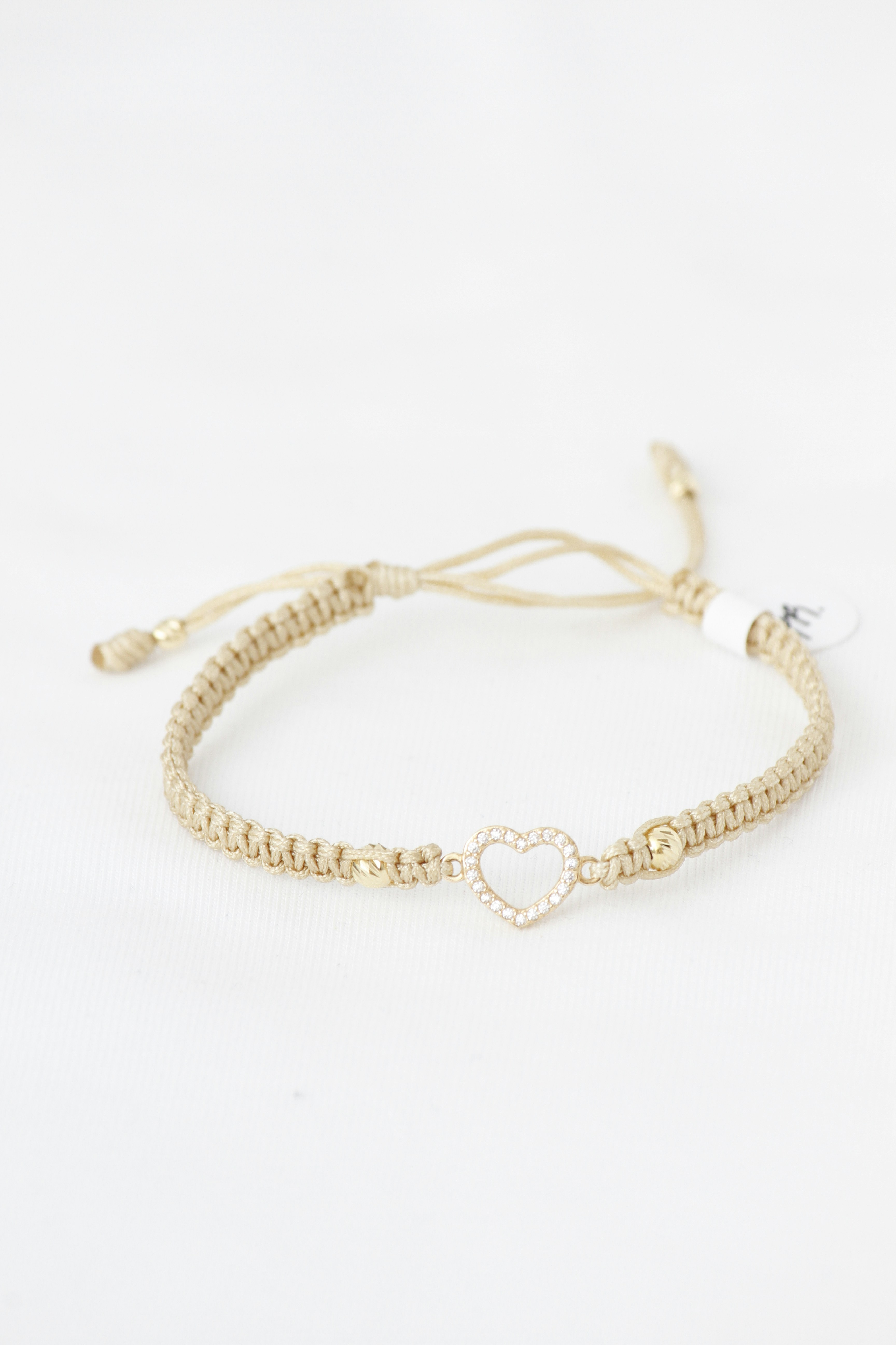 Gold Heart: Delicate Weave Bracelet Resting for a Gentle Spotlight
