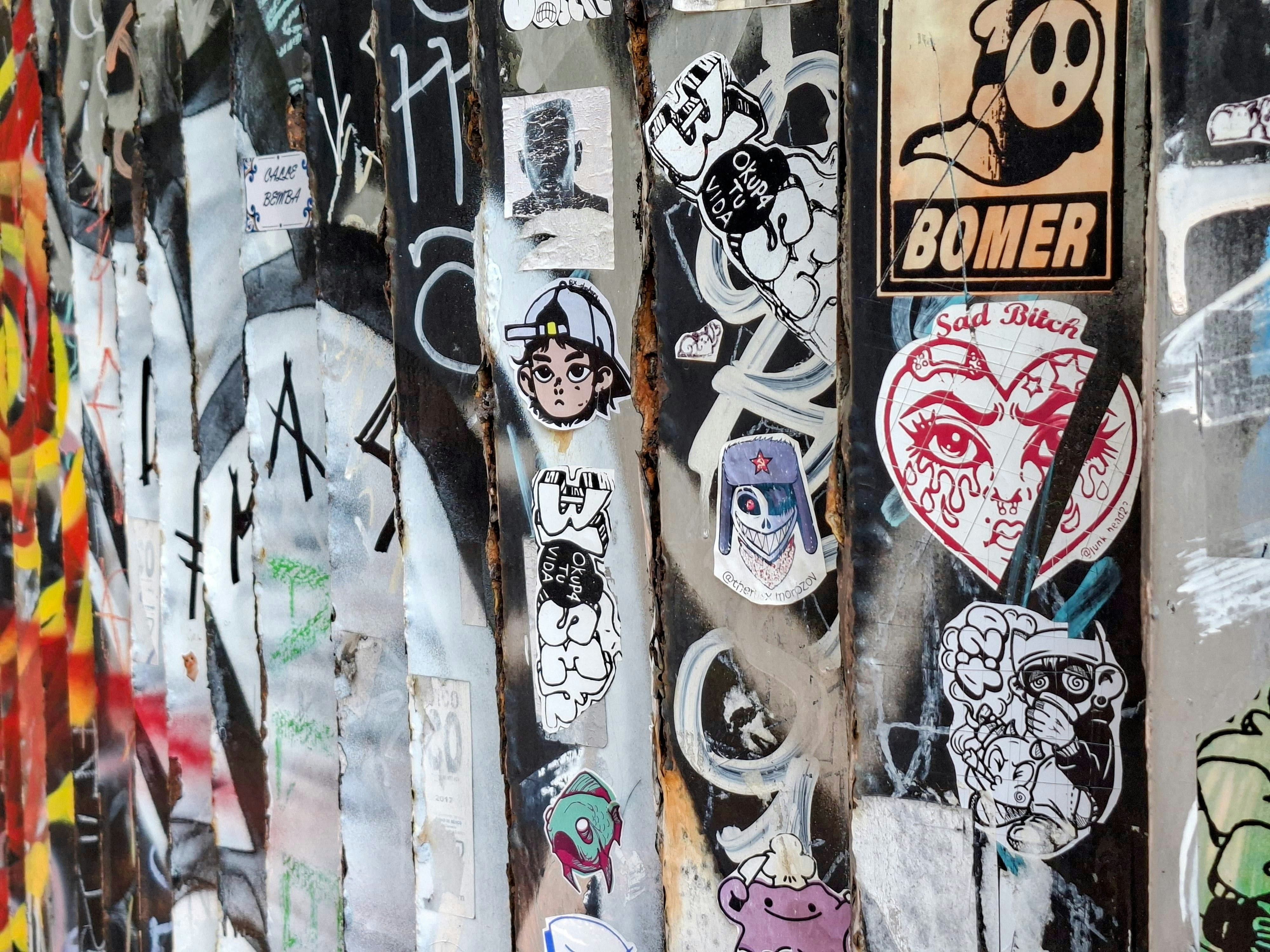 Stuck with Stickers: Vertical Graffiti Alley of Enigmatic Faces