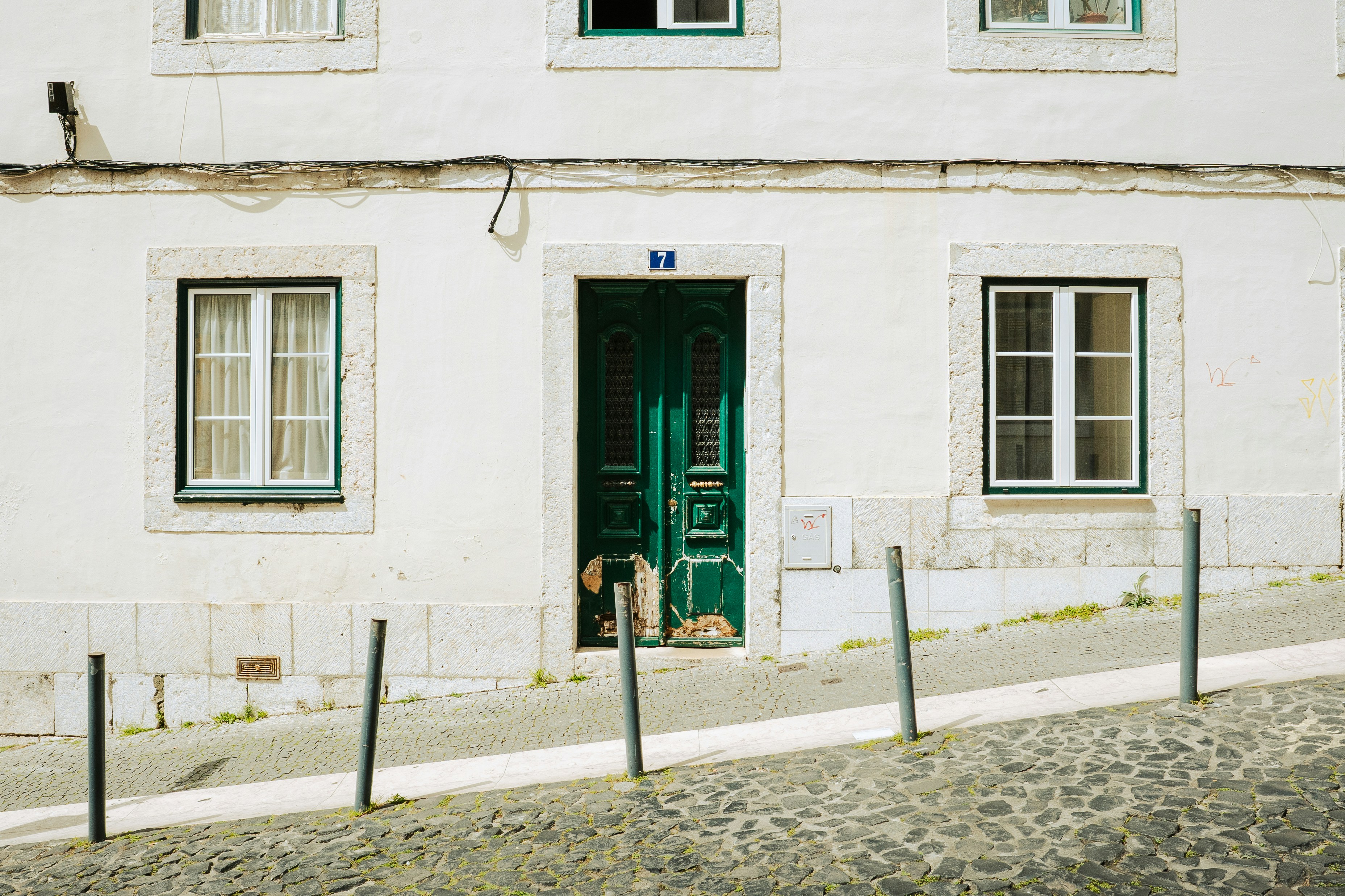Green Door on a Quiet Cobblestone Street