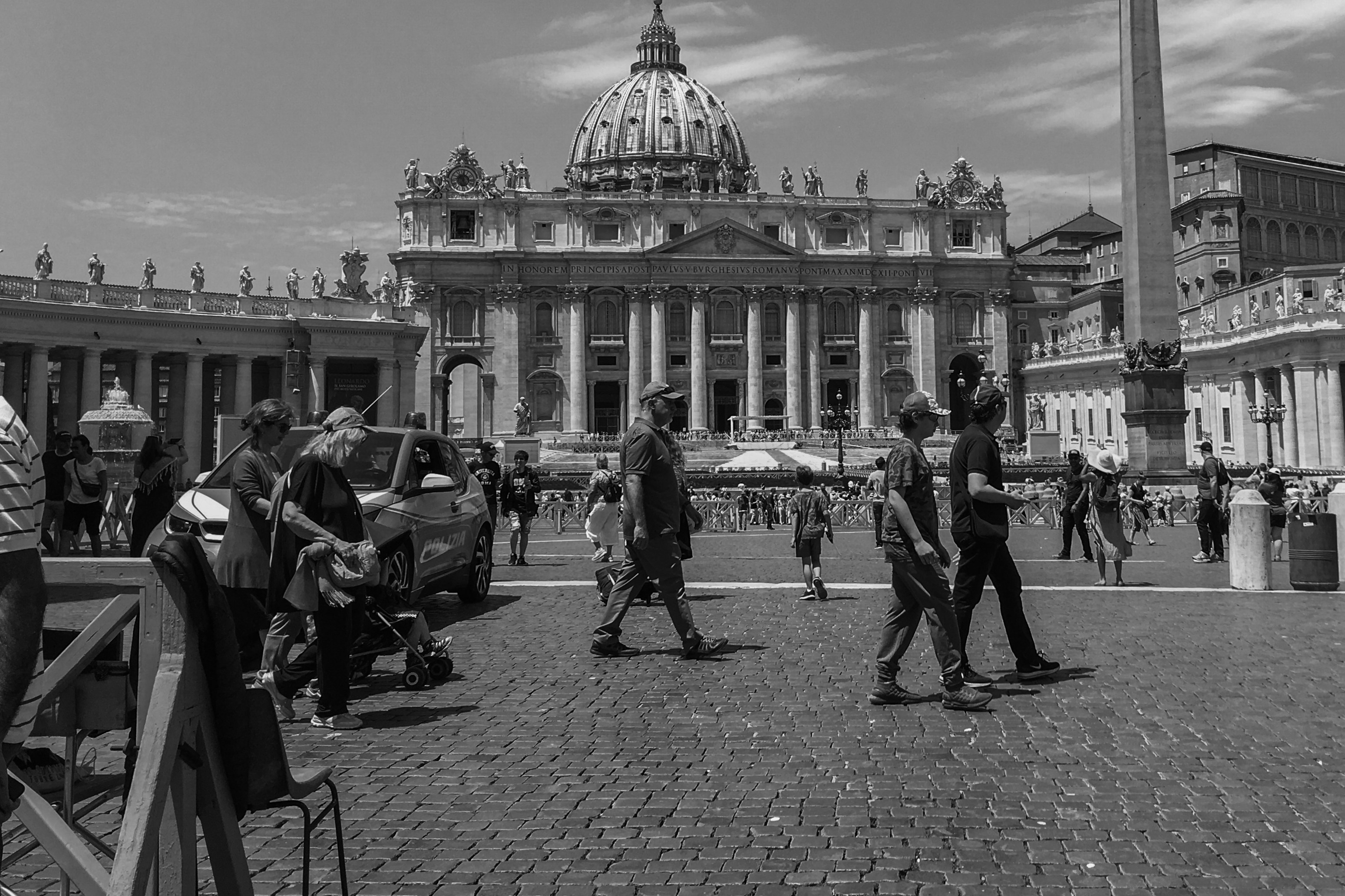 Piazza di San Pietro: Strolling Silhouettes in a Dimmed Colonnade