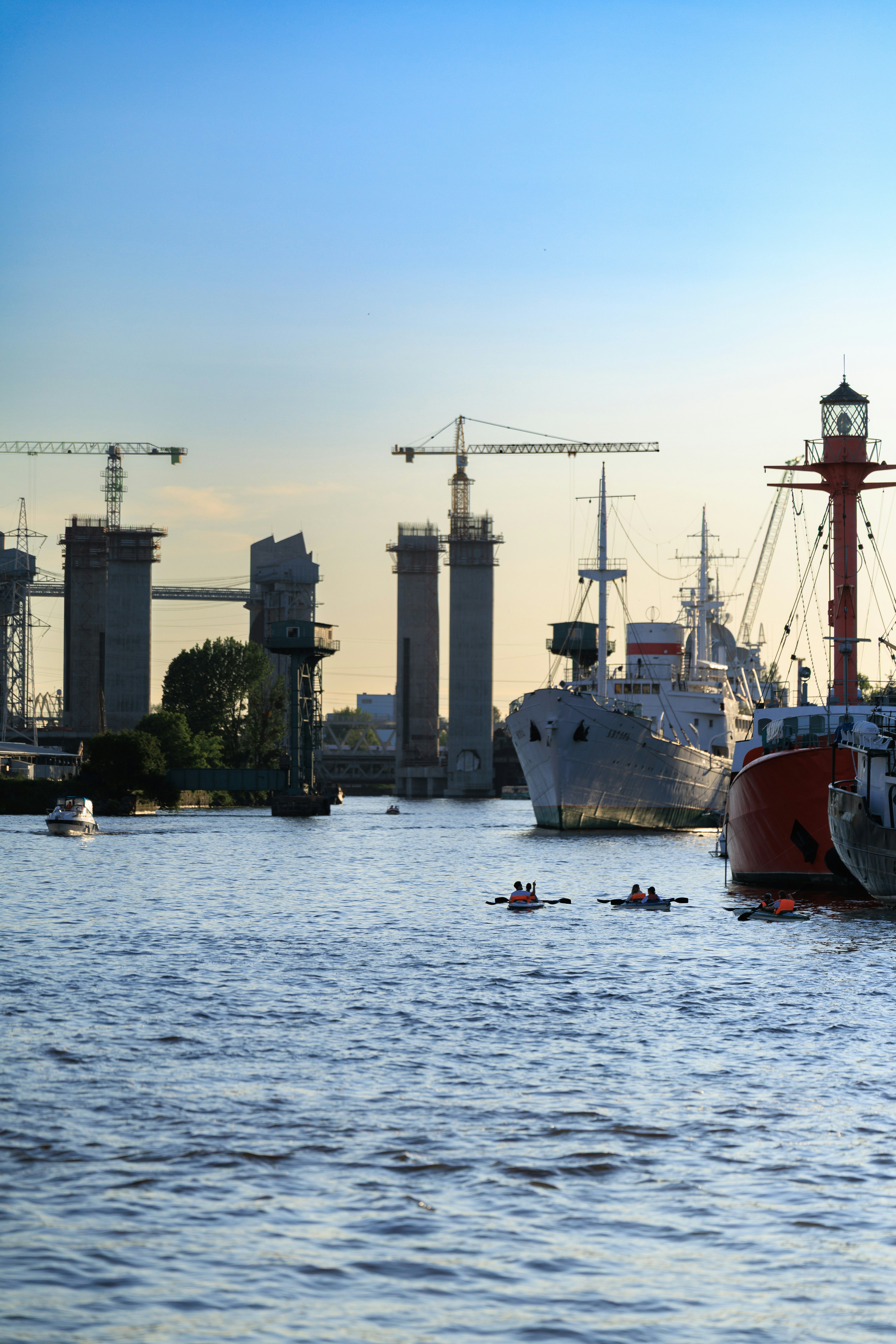 Harbor at Dusk: Bridges, Ships, and a Red Lighthouse