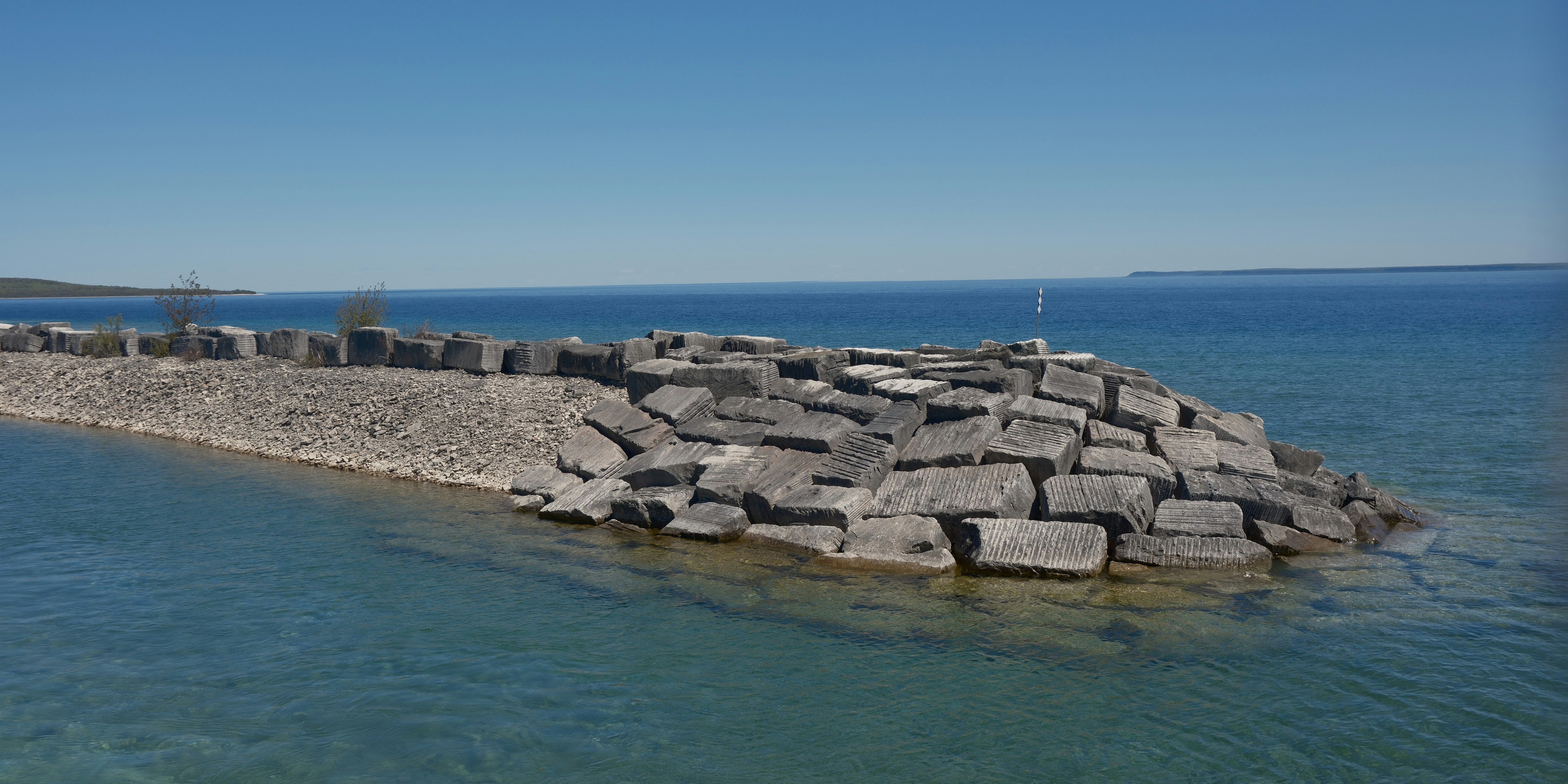 Stone Breakwater embracing a calm sea under a clear sky