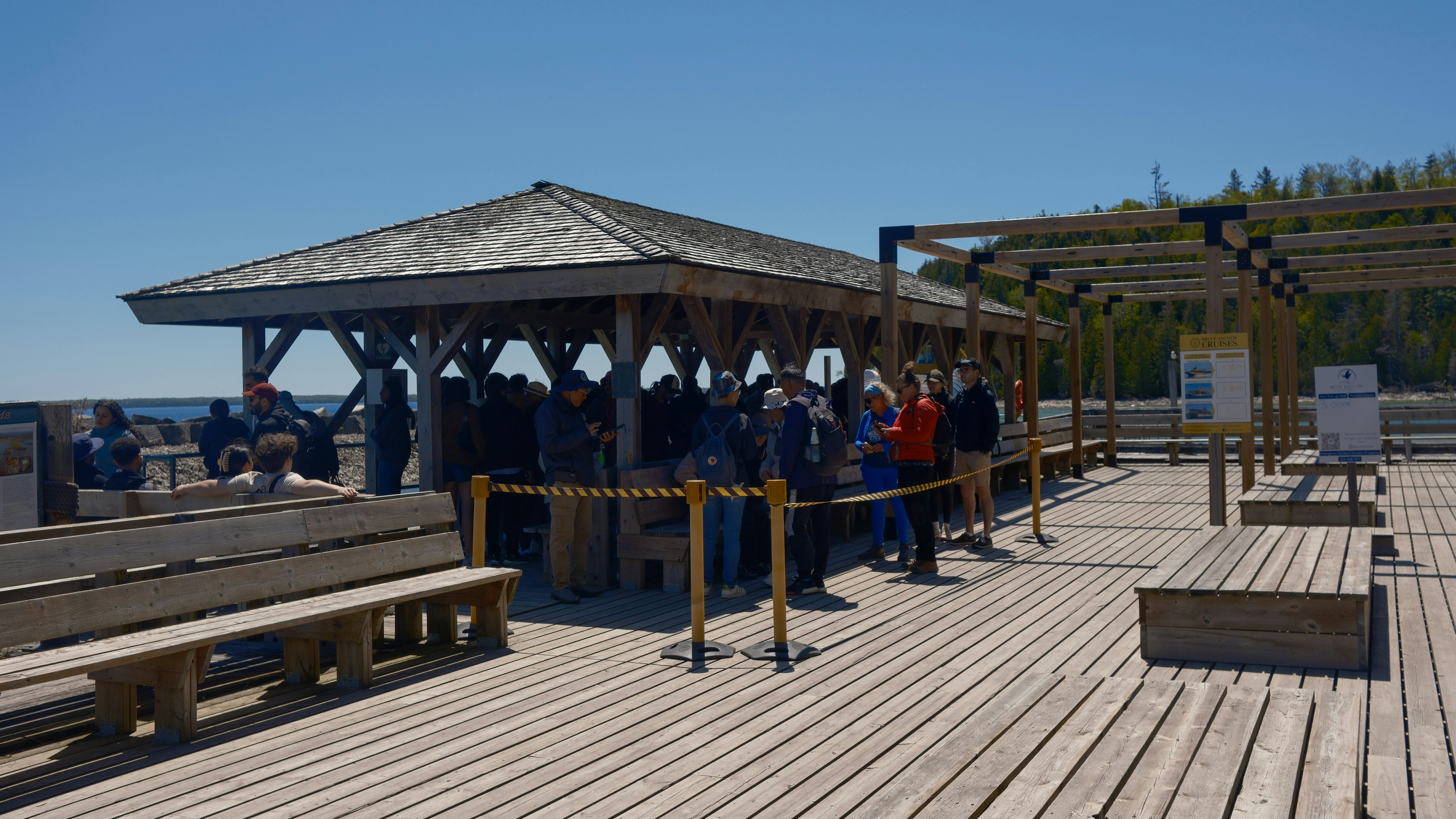 Crowd Under a Wooden Pavilion on a Boardwalk by the Sea