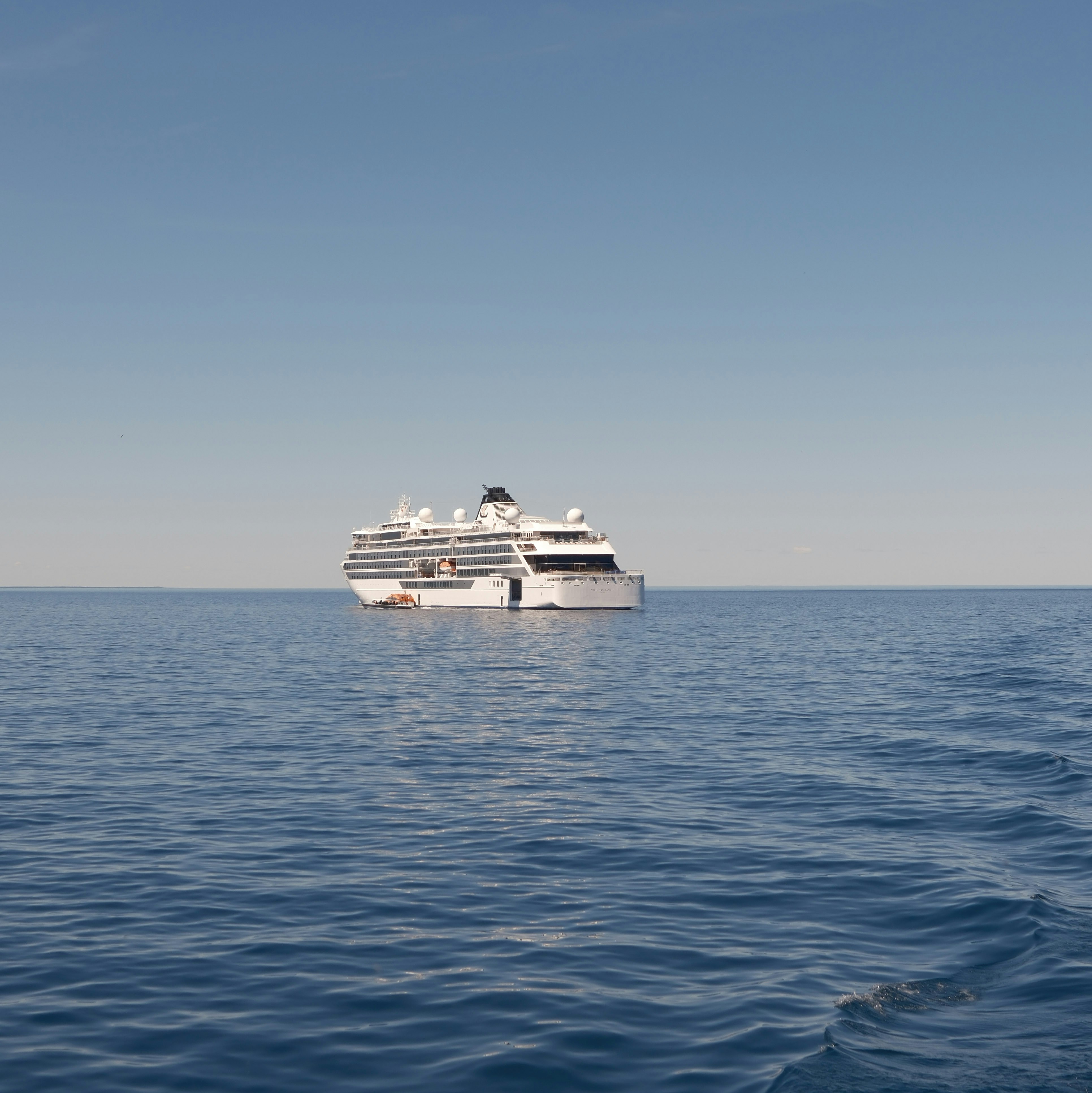 Voyage in Full Horizon: A Passenger Vessel Anchored on Calm Atlantic Waters