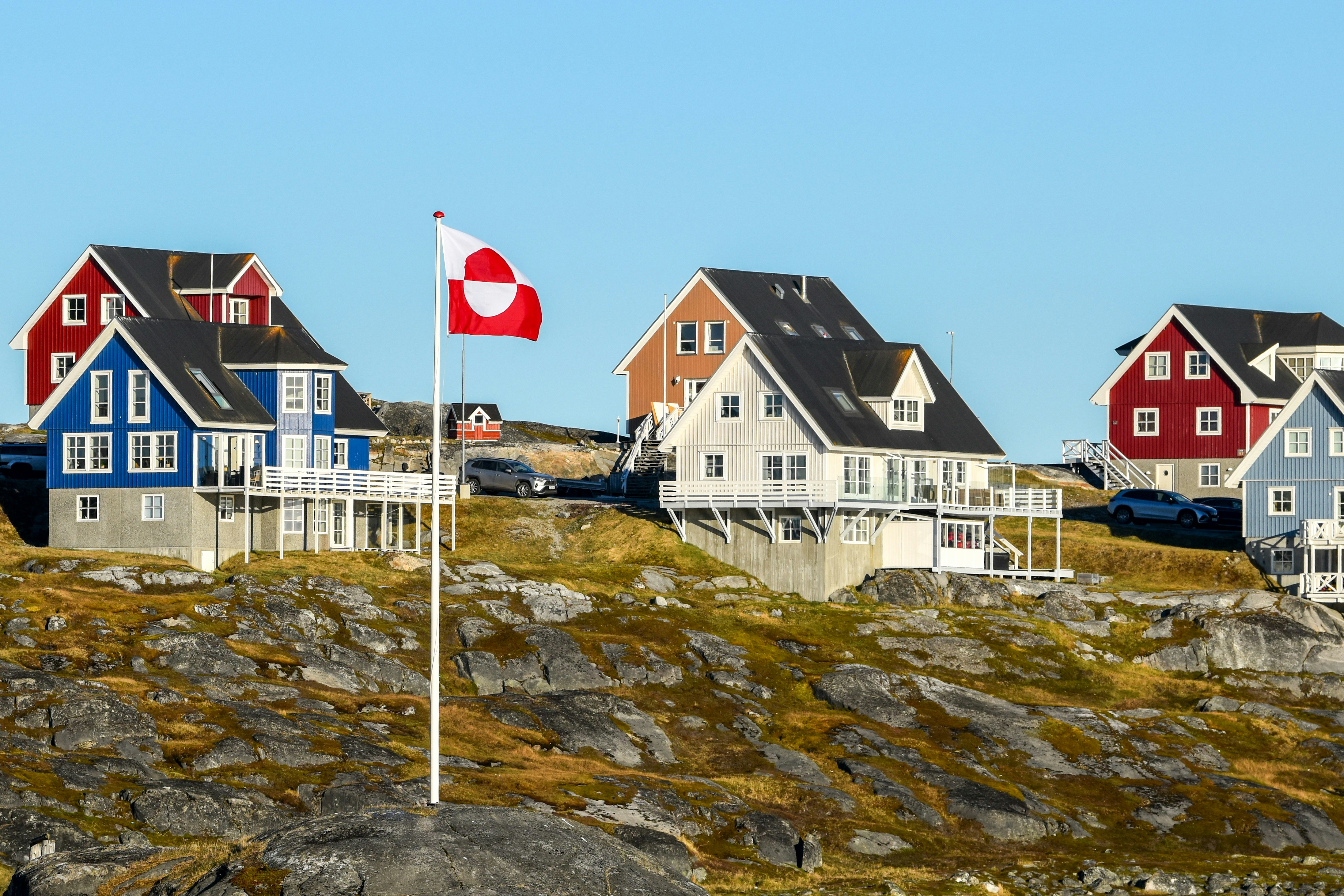 Colorful Row of Coastal Cottages Over rocky shoreline