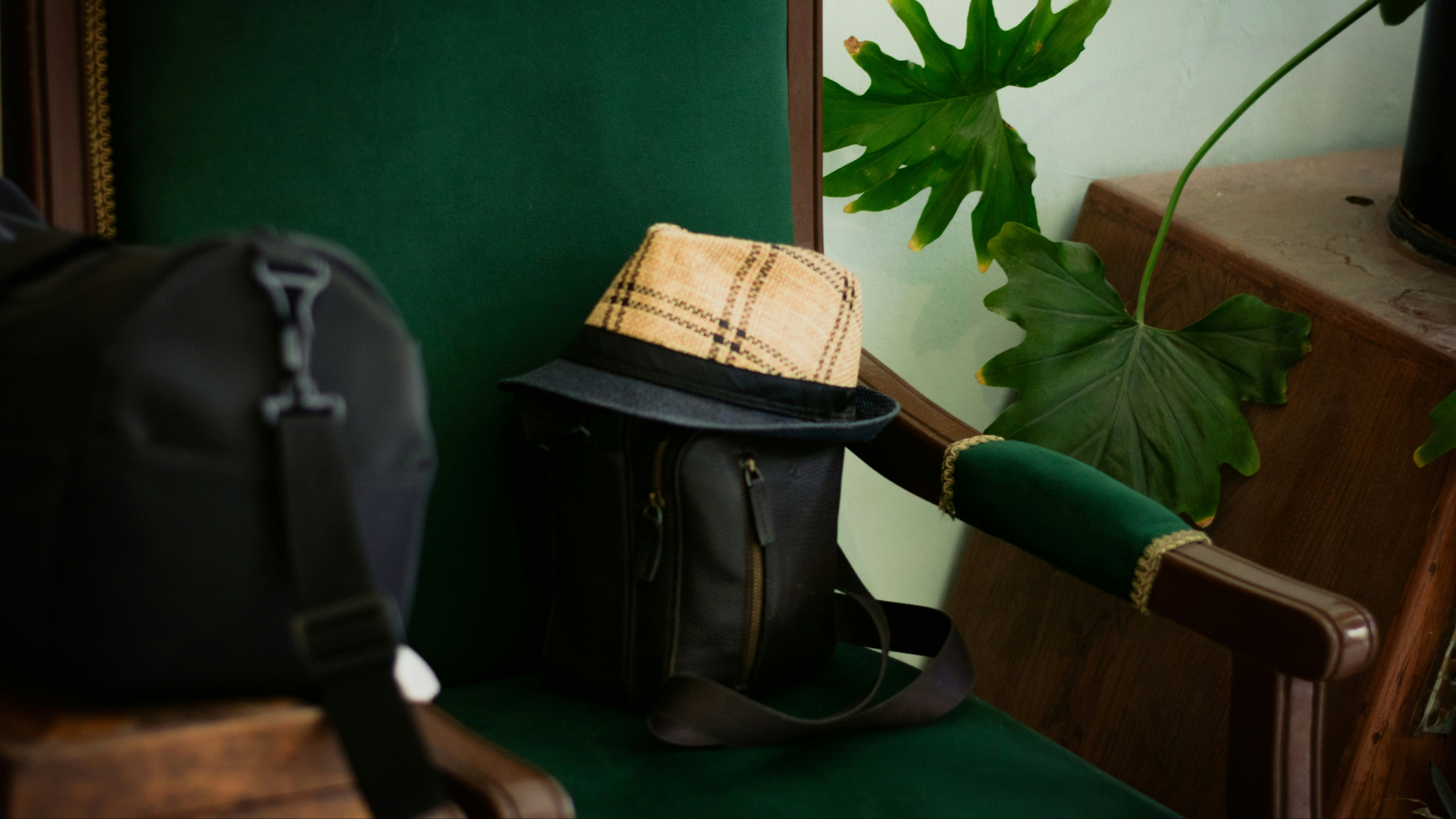 Straw Fedora Adrift on a Green-Backed Seat