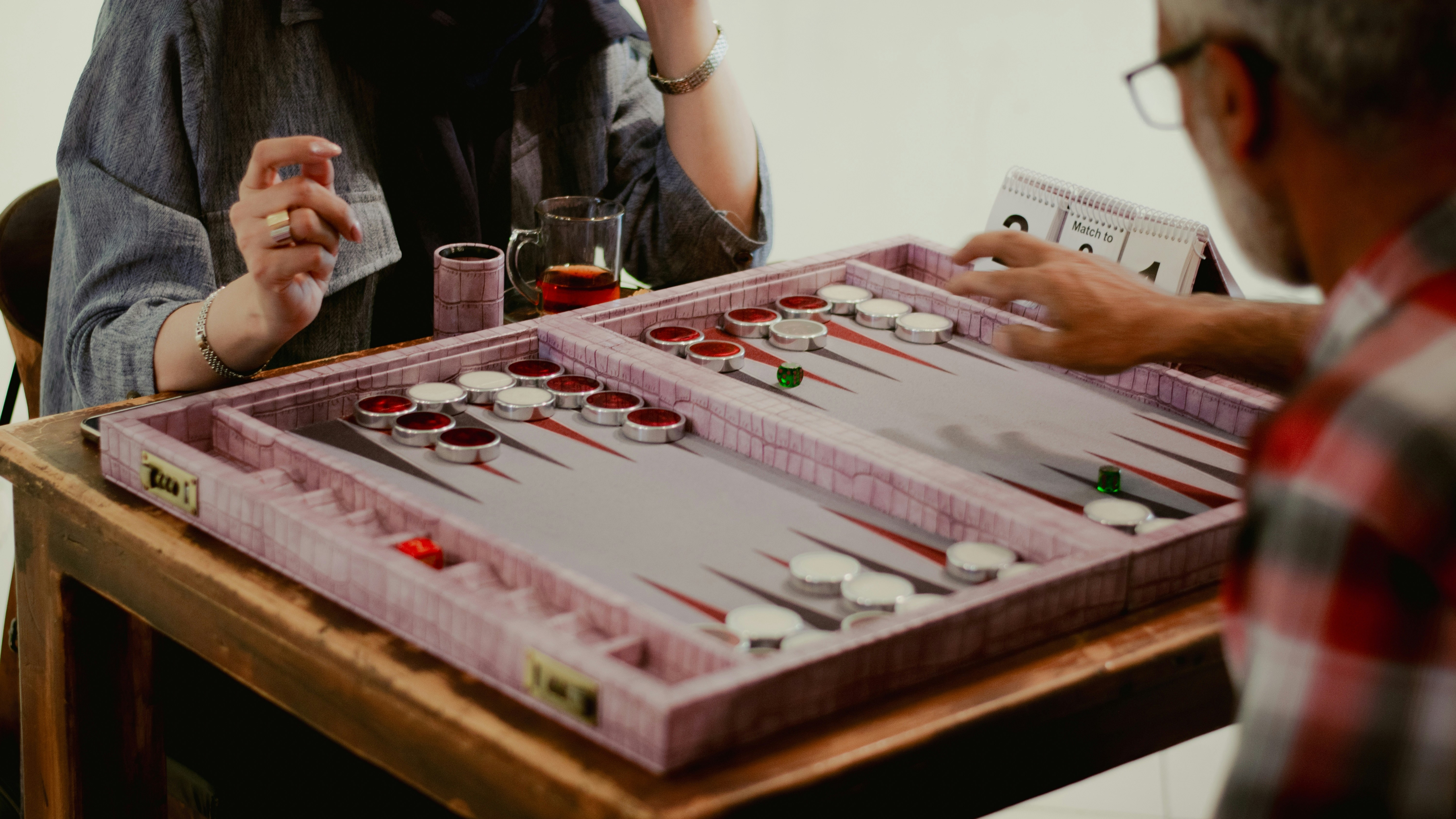 Midgame Strategy Unfolds Across a Pink-Trimmed Backgammon Board