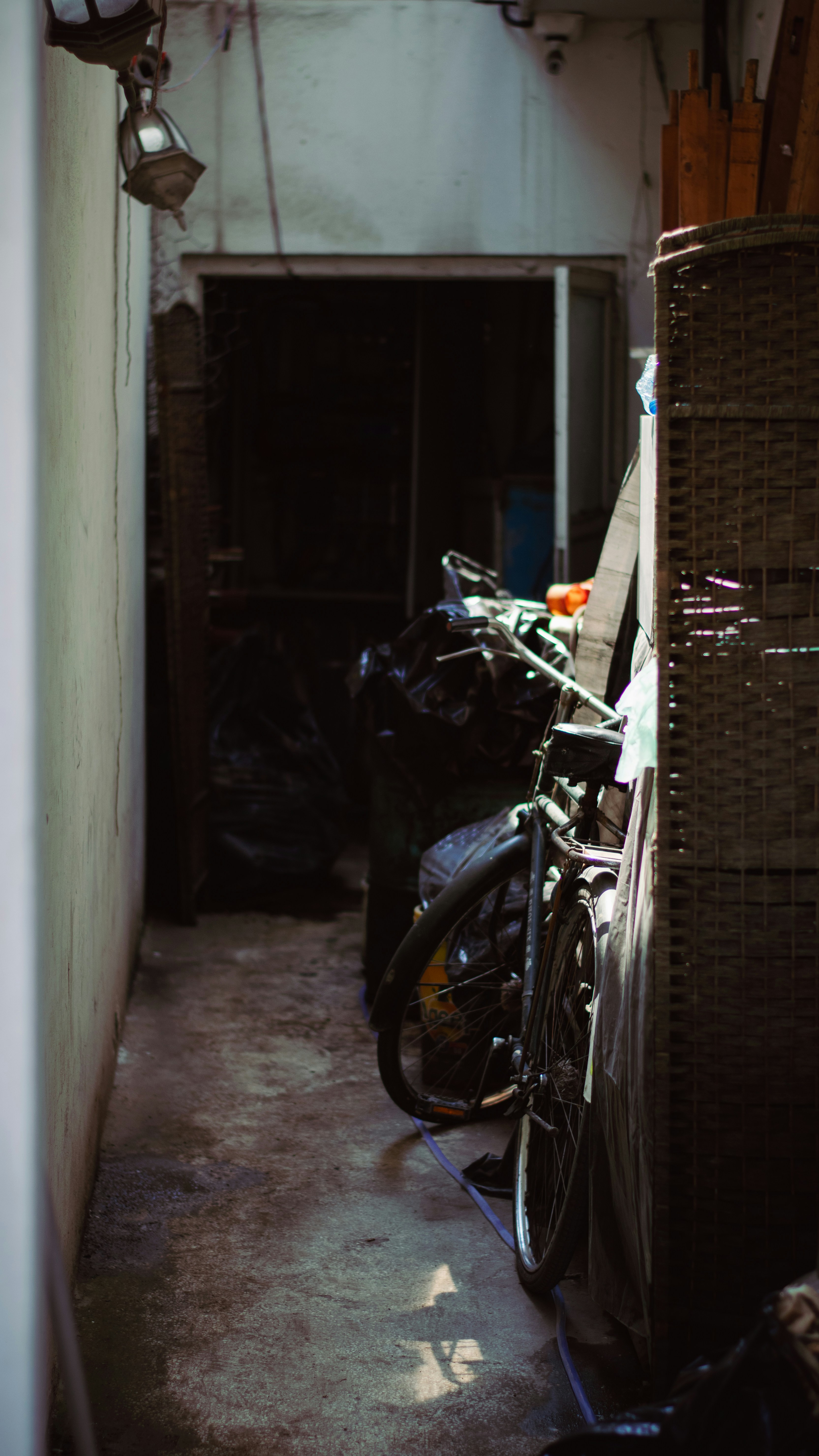 Narrow Alley with Bicycle and Cluttered Back Wall