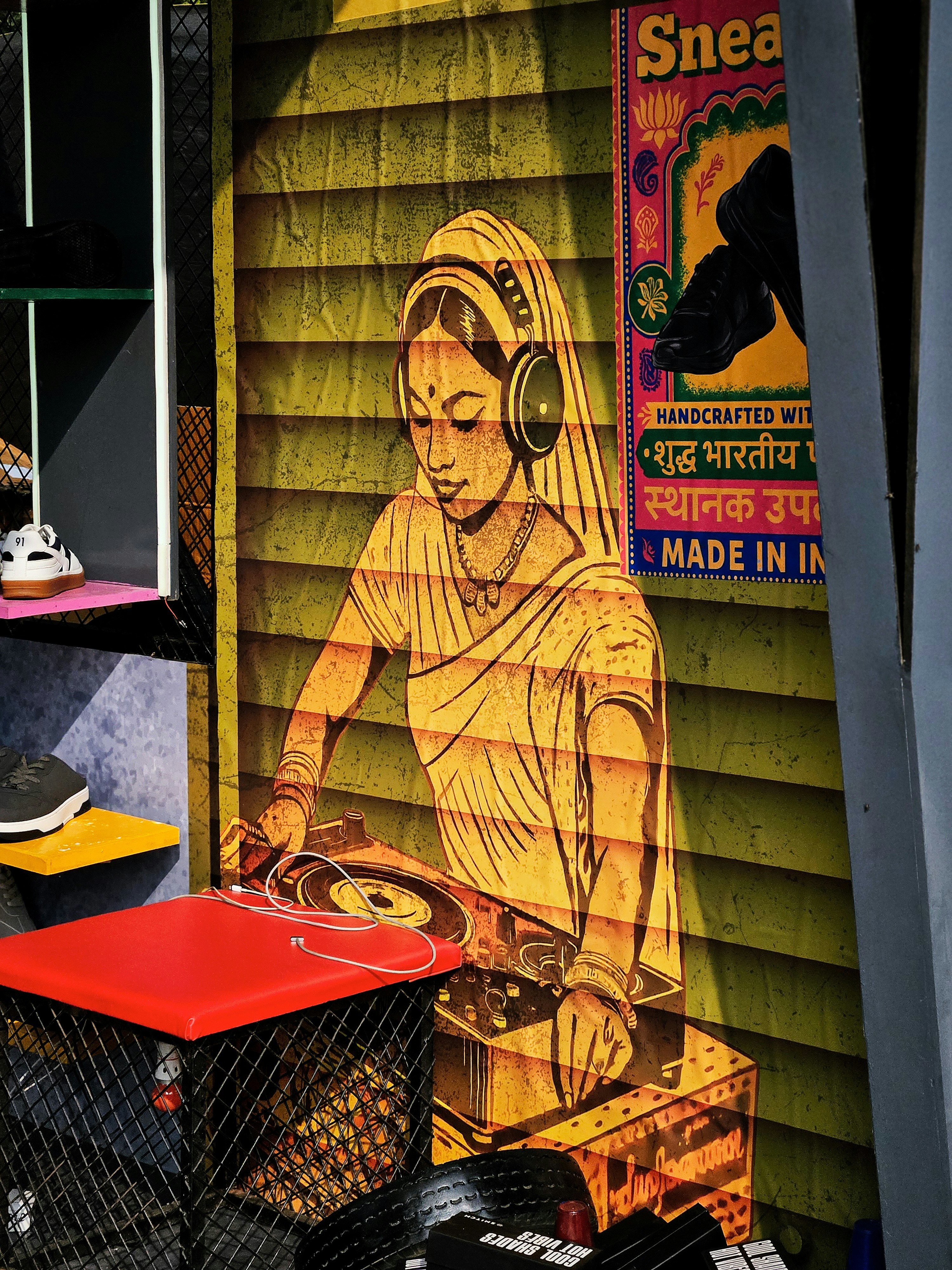 Vibrant street art of an indian woman djing.