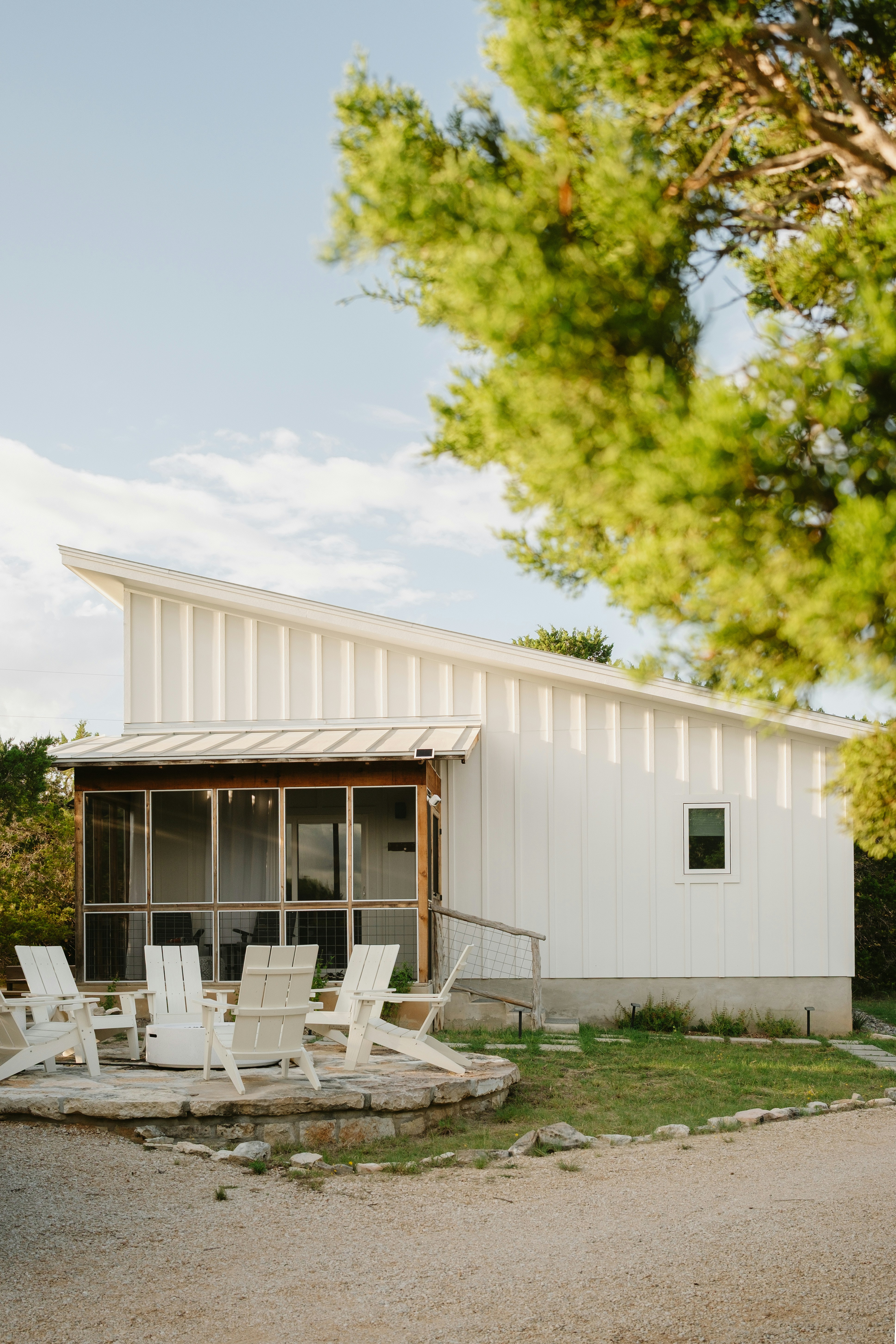 Architectural Retreat: White Modern Cabin with Adirondack Seating