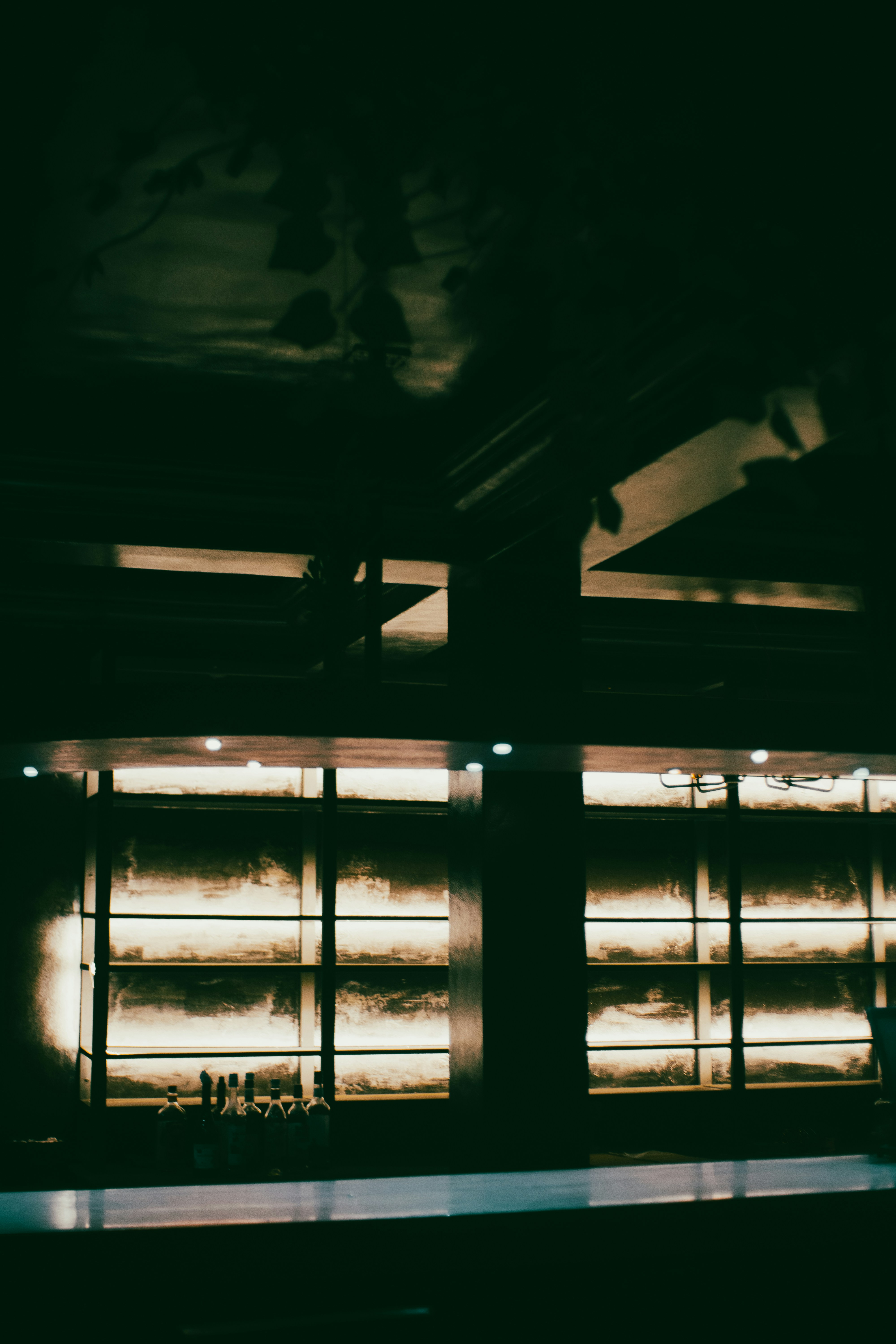 Amber Window Reflections Over a Dim Bar