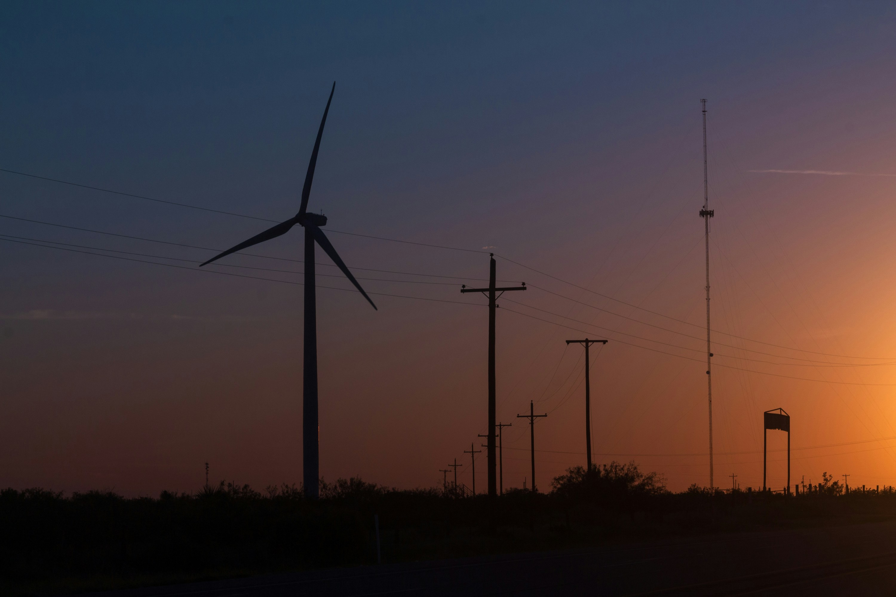 Silent Horizon: Wind Turbine Silhouette at Dusk