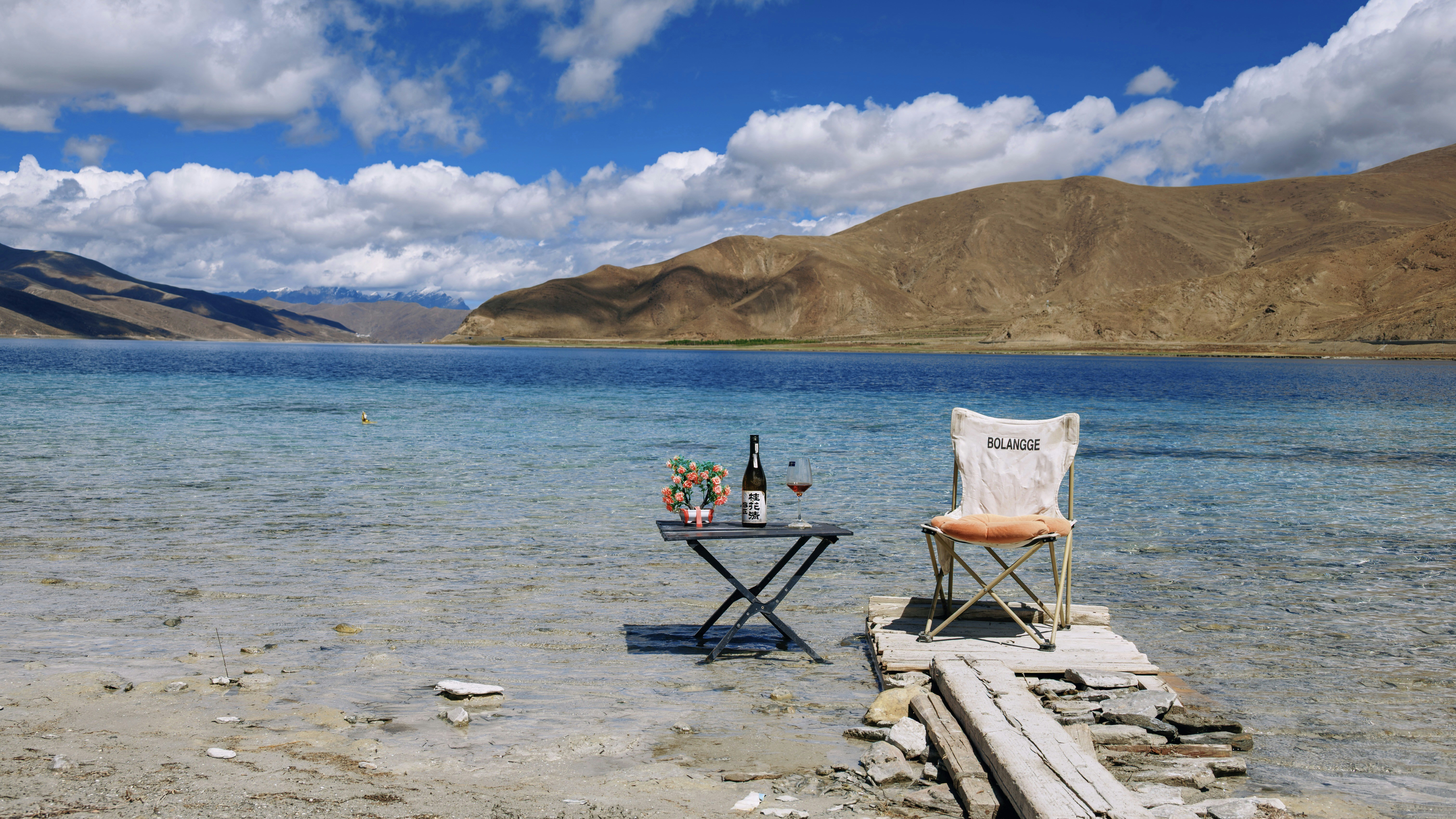 A Quiet Lakeside Setup: Champagne Glasses by the Water's Edge