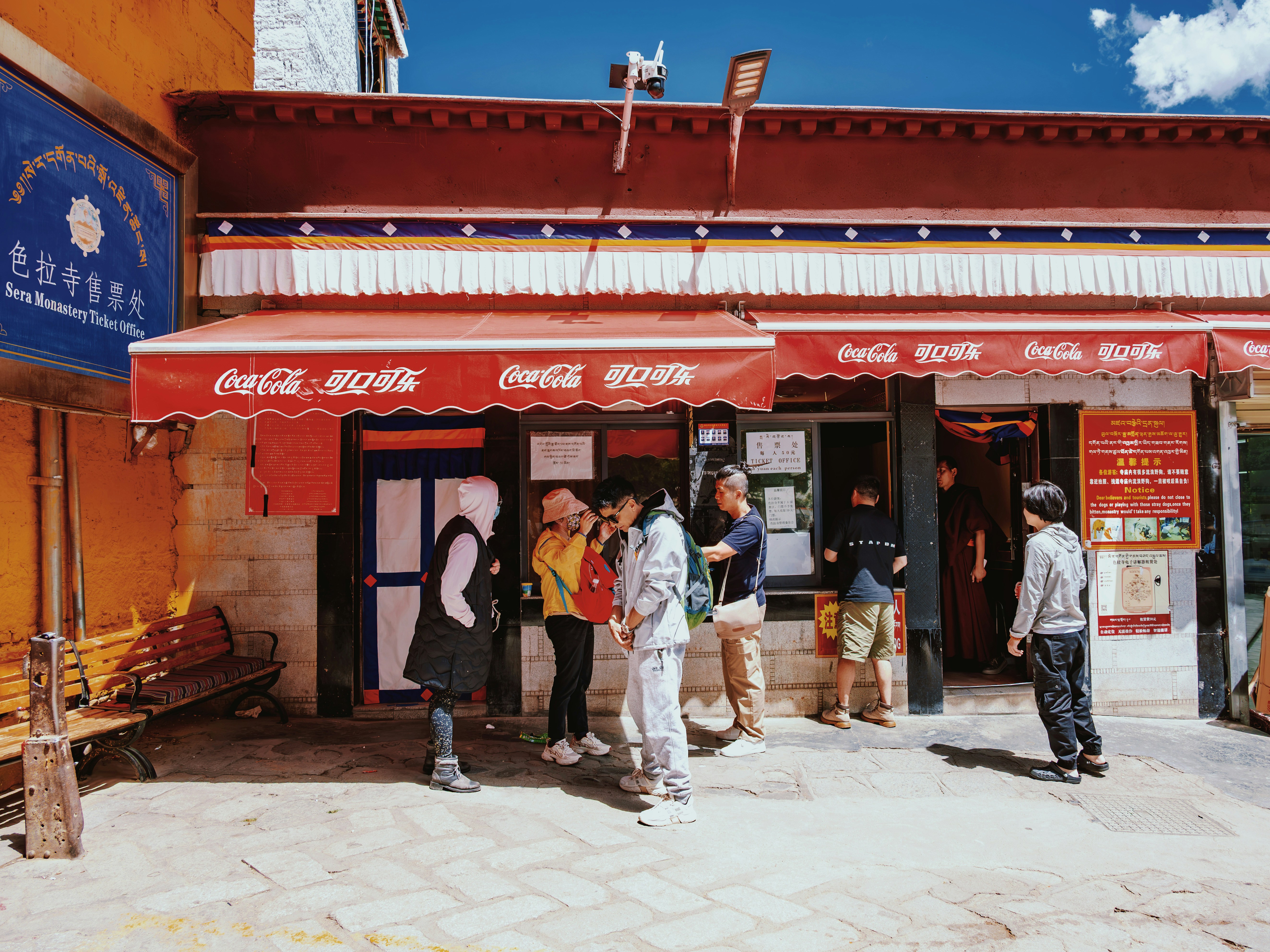 Bus Stop Courtyard: A Quiet Moment Under Red Awnings